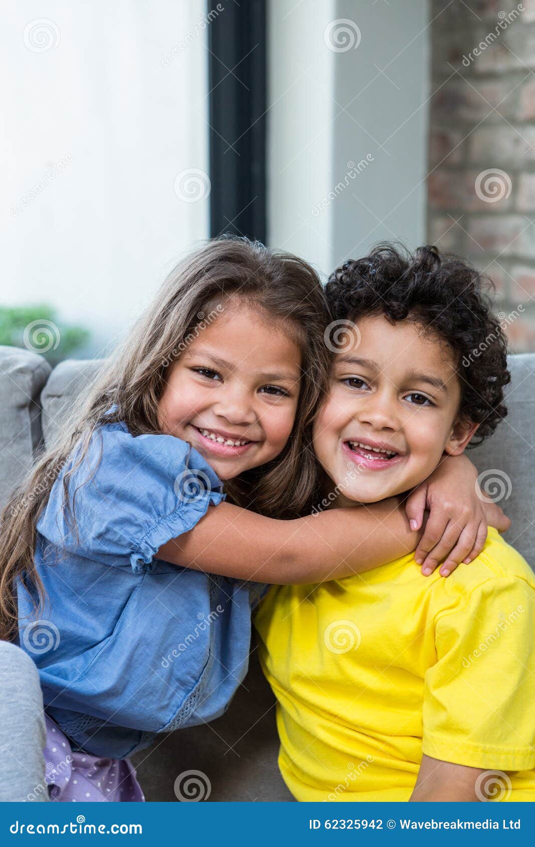 Cute Siblings Hugging on the Sofa Stock Photo - Image of household ...