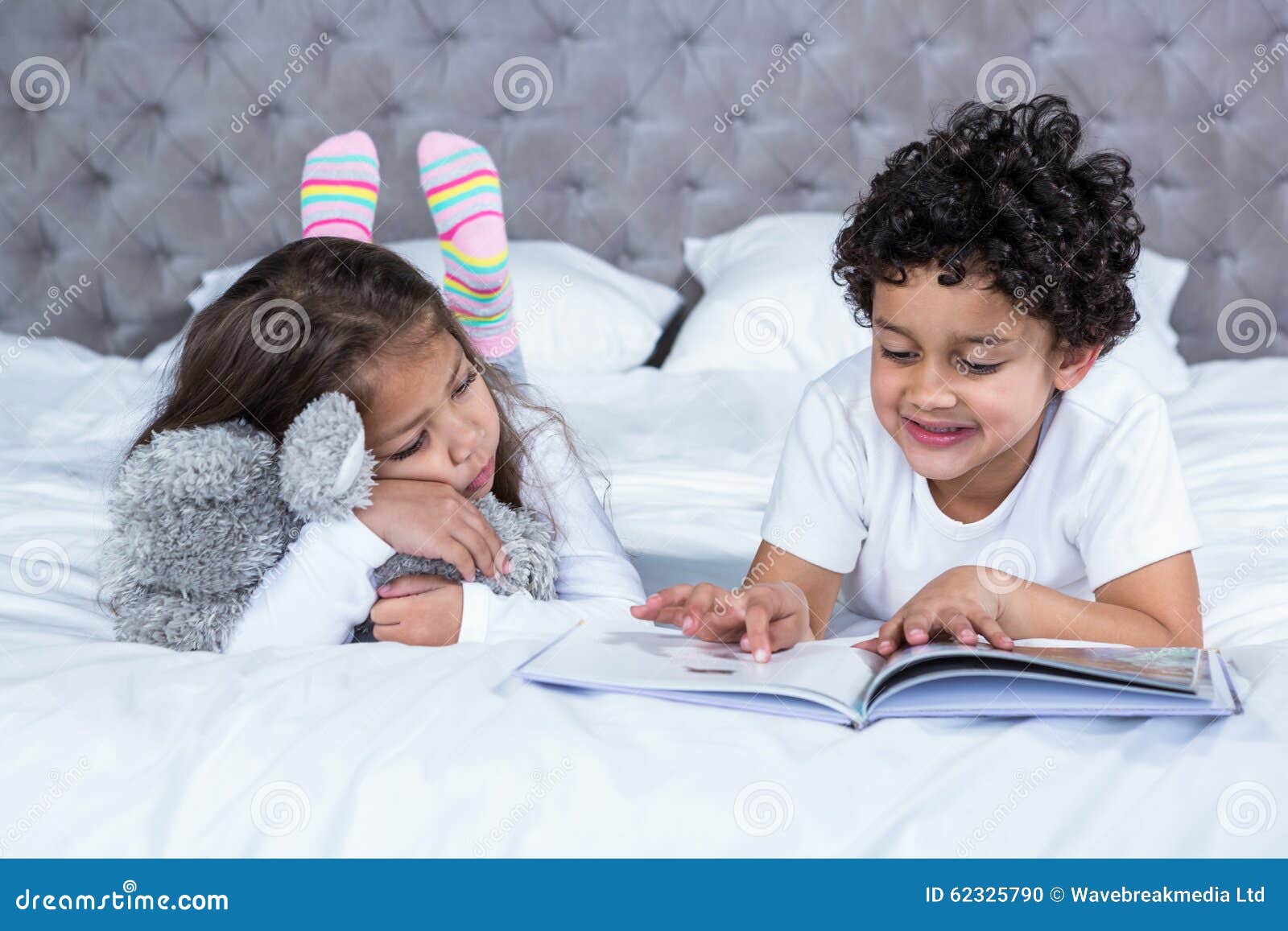 Cute Siblings Reading a Book on the Bed Stock Photo - Image of cheerful ...