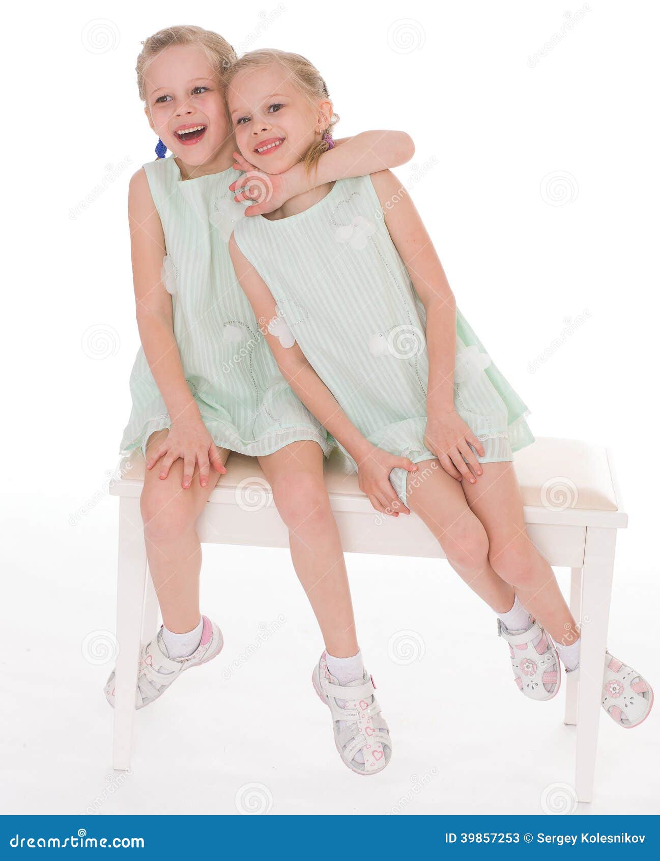 Cute Sisters Having Fun Sitting on a Chair. Stock Image - Image of ...