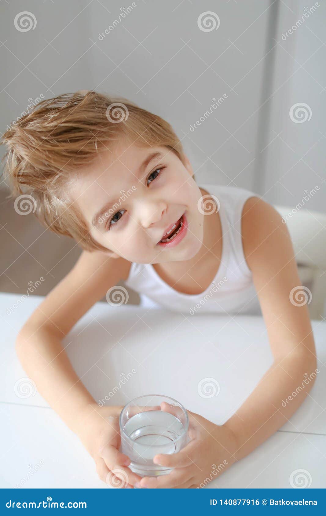 Cute Smiling Boy with Glass of Water on a White Background Stock Photo ...