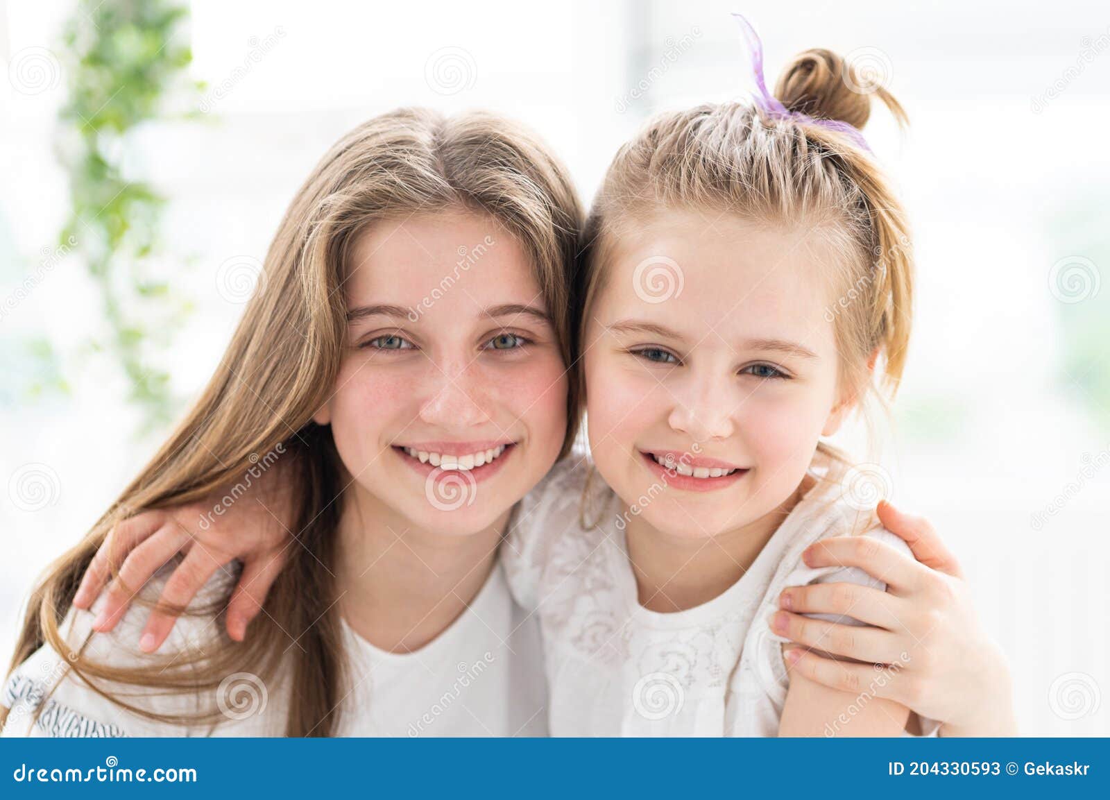 Cute Smiling Sisters Embracing Stock Image - Image of indoors, happy ...