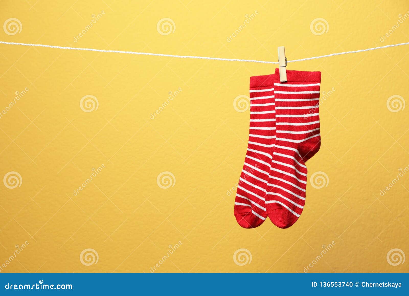 Cute Socks on Laundry Line Against Color Background. Stock Photo ...