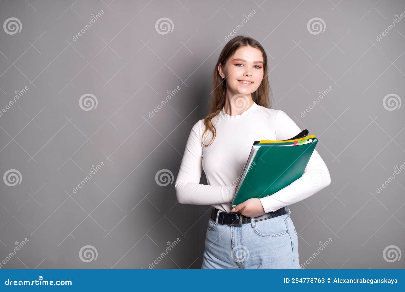 A Cute Student Girl Holds Notebooks for Notes and Smiles Stock Image ...