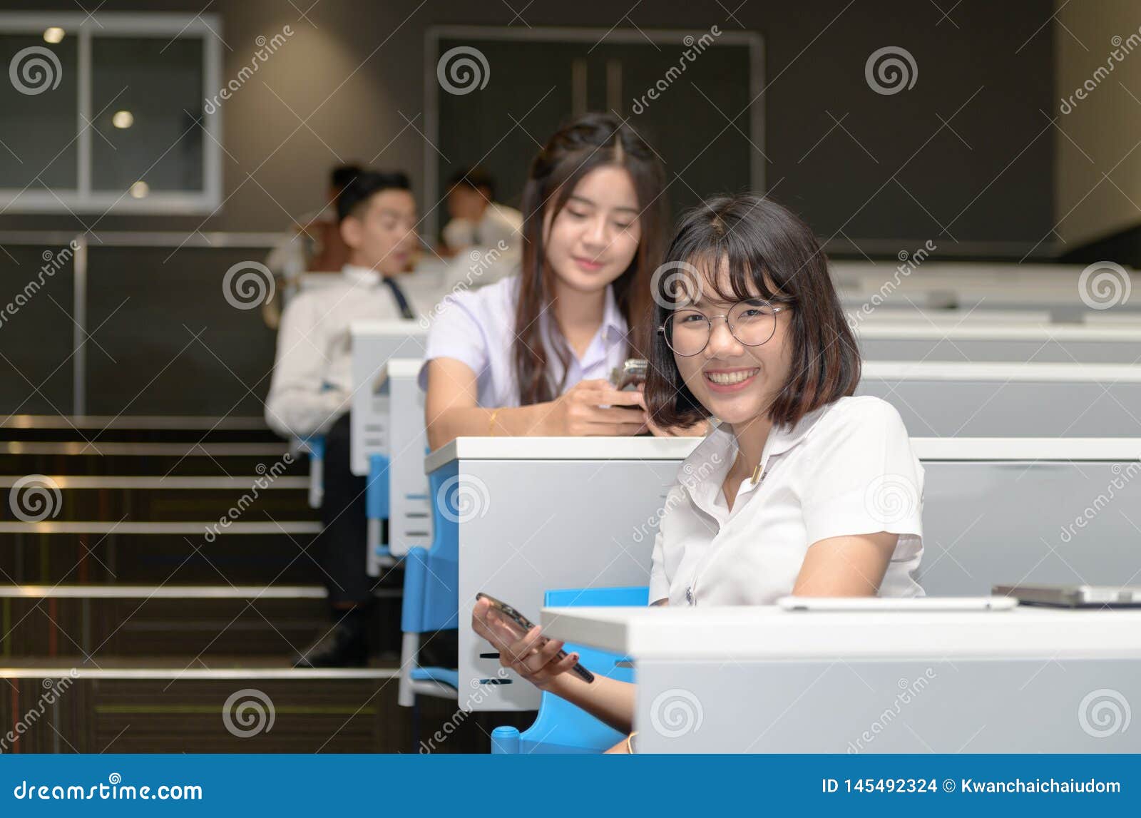 Cute Student Play Mobile Phone in Classroom Stock Photo - Image of ...