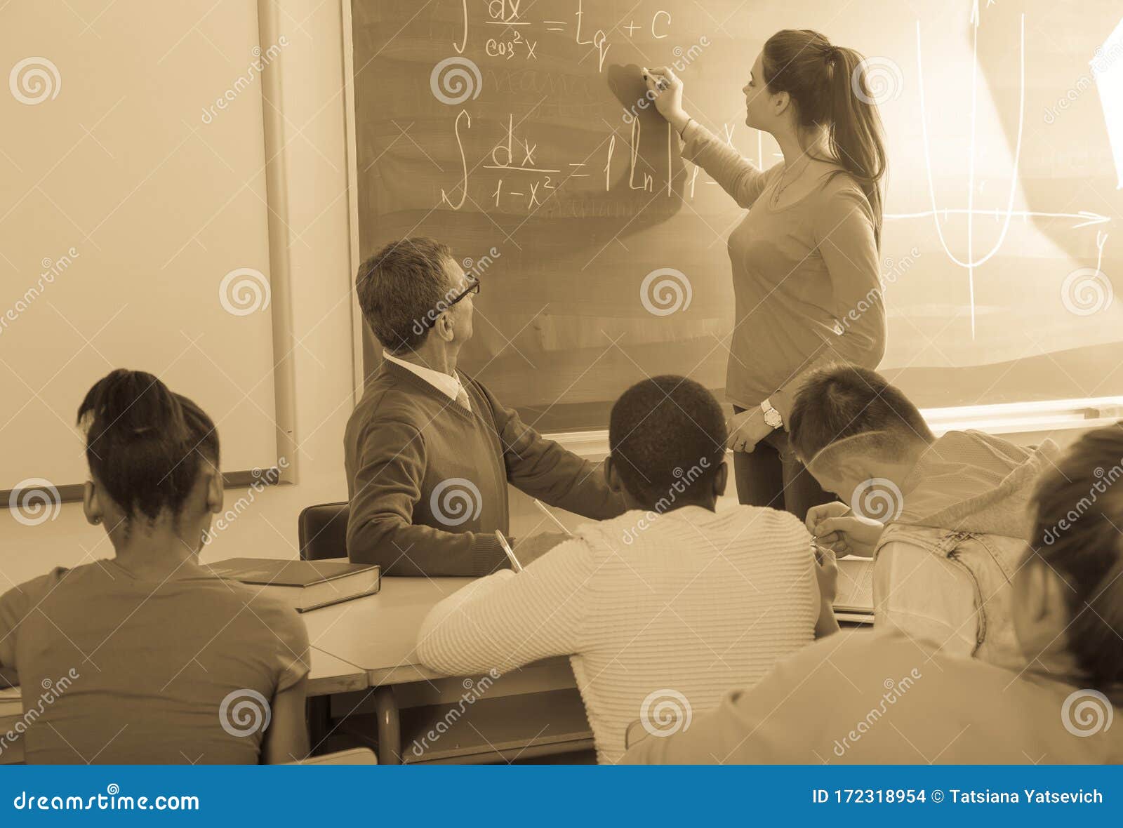 Cute Student Solves Task Near Blackboard in Classroom Mathematics Stock ...