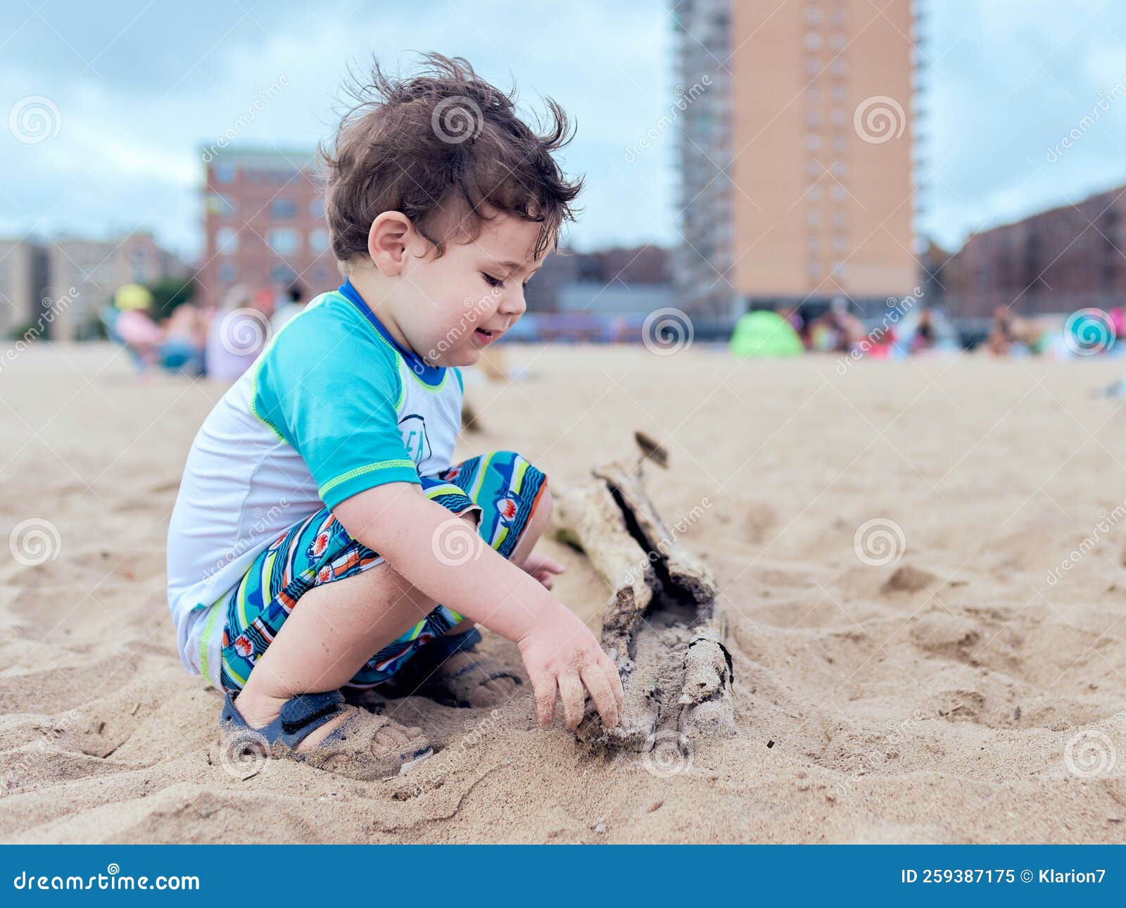 Cute Toddler Playing on the Beach and Trying To Move the Log Stock ...
