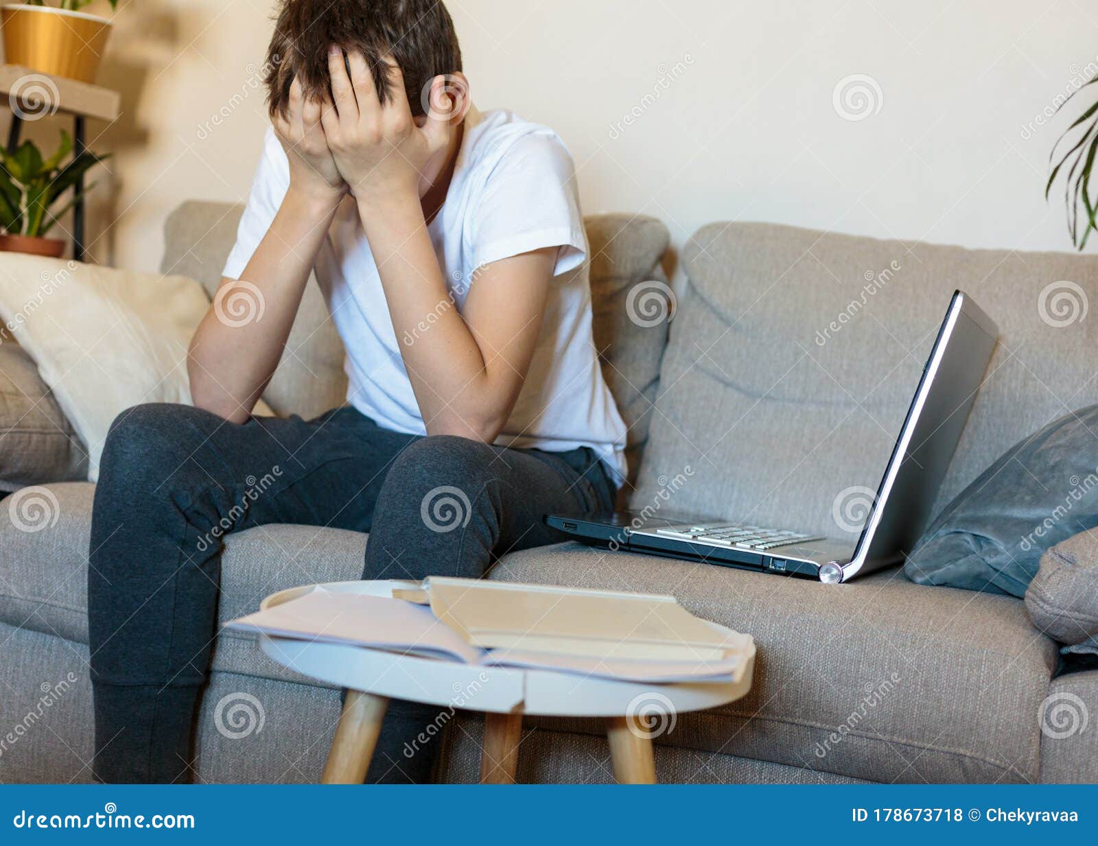 Cute Upset Boy in White T Shirt Sitting on the Couch in the Living Room ... Cute Upset Boy in White T Shirt Sitting on the Couch in the Living Room ...