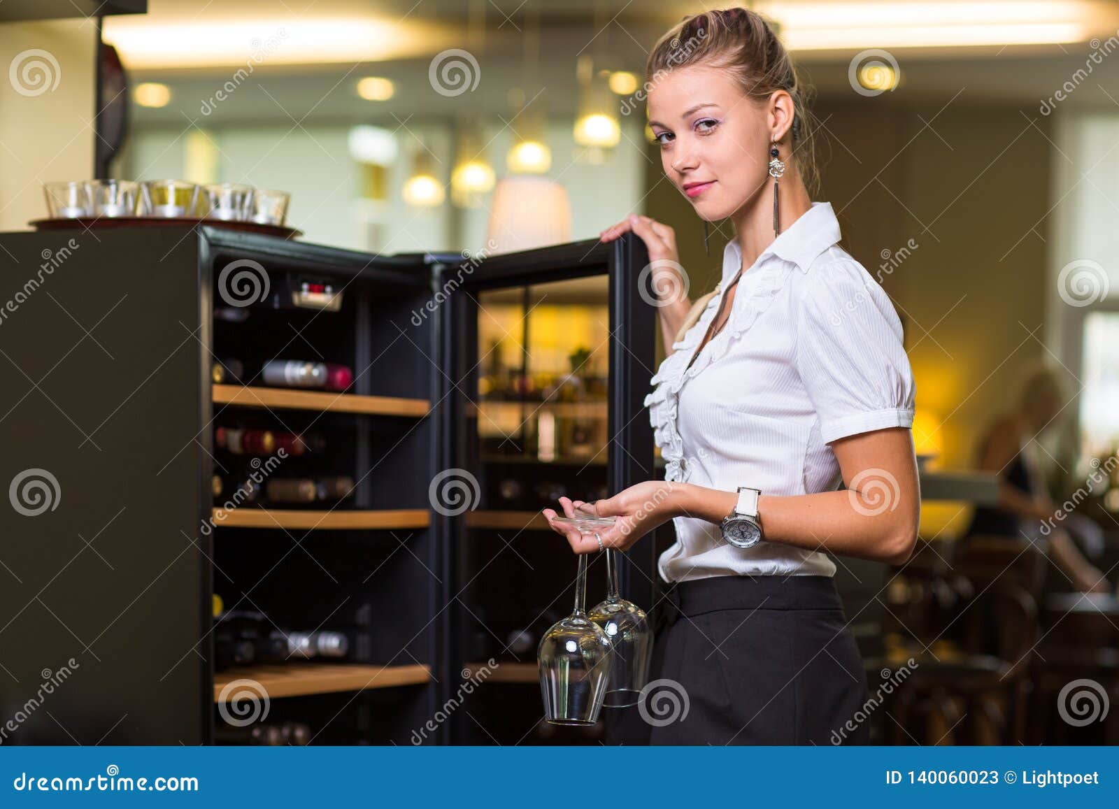 Cute Waitress Getting a Bottle of a Nice Wine for the Guests Stock ...