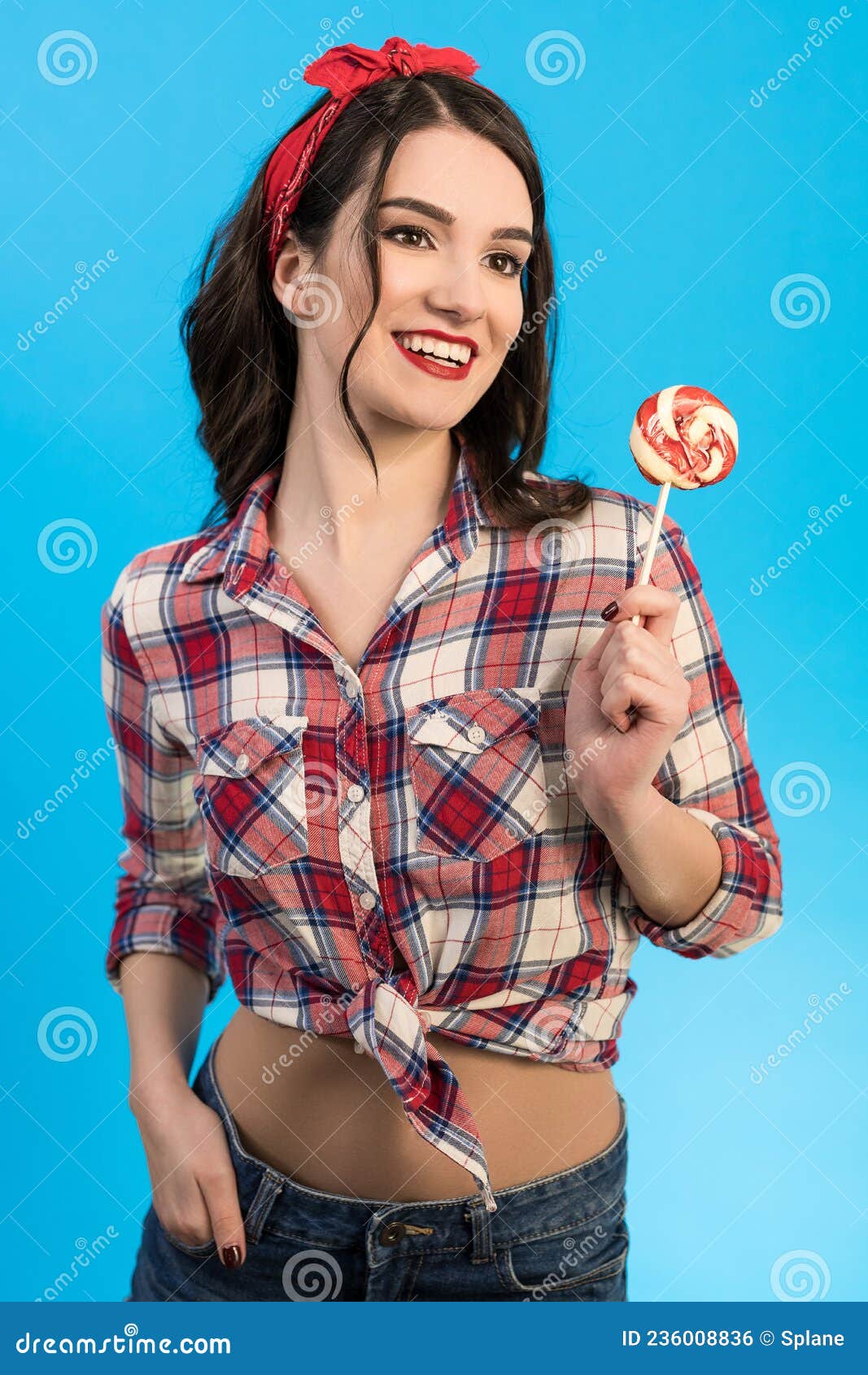 The Cute Woman with a Candy Standing on the Blue Background. Stock ...