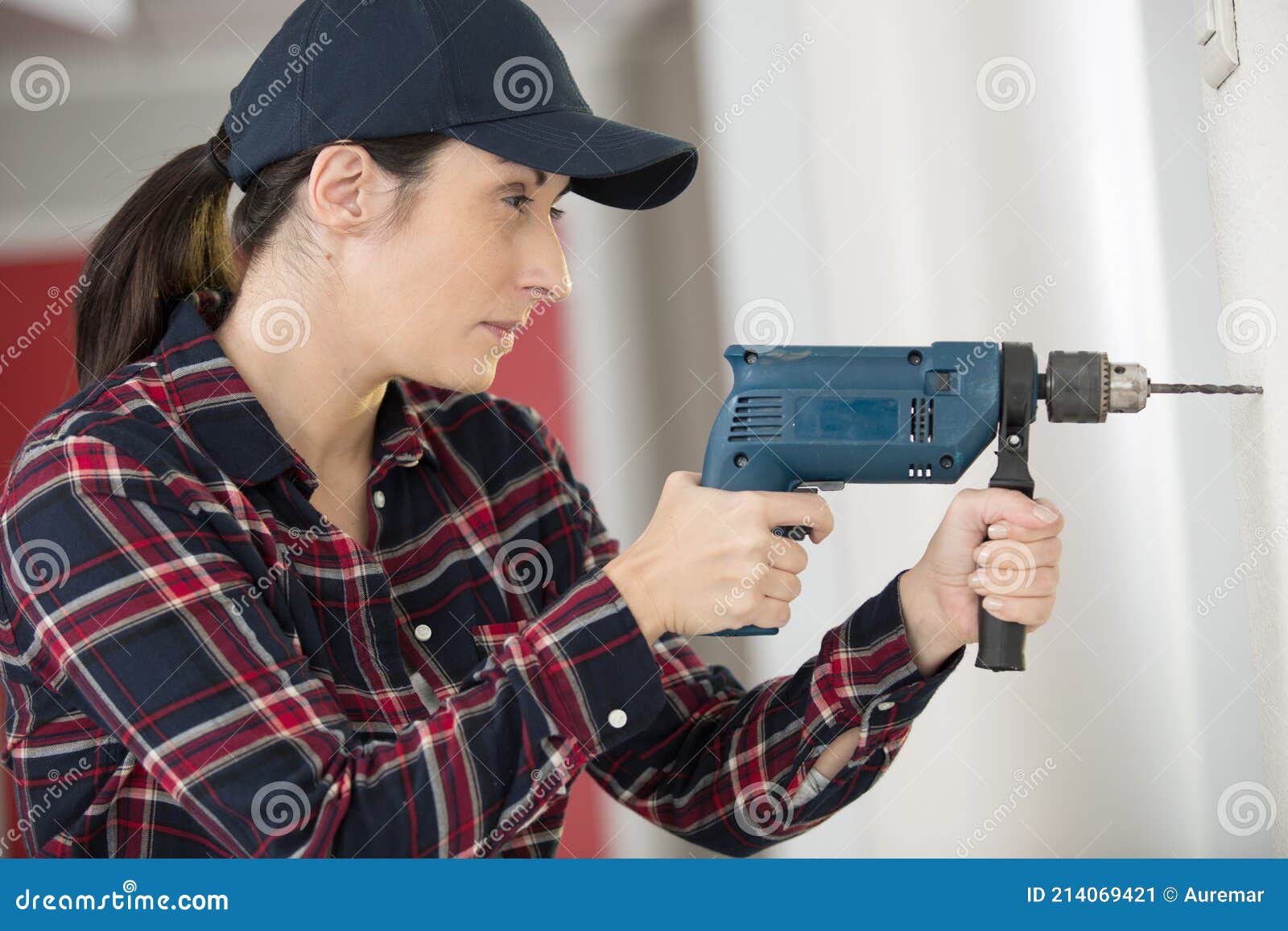 Cute woman drilling stock image. Image of brunette, work - 214069421