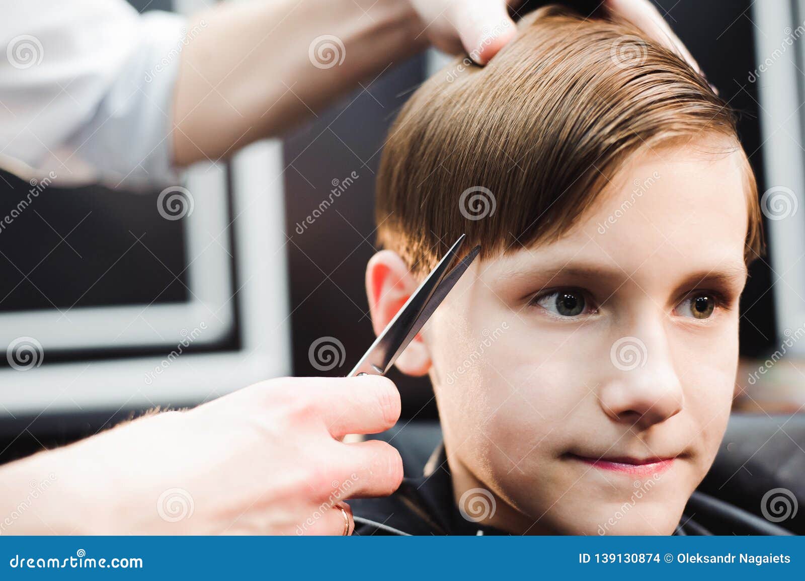 Cute Young Boy Getting a Haircut in a Salon Stock Photo - Image of ...
