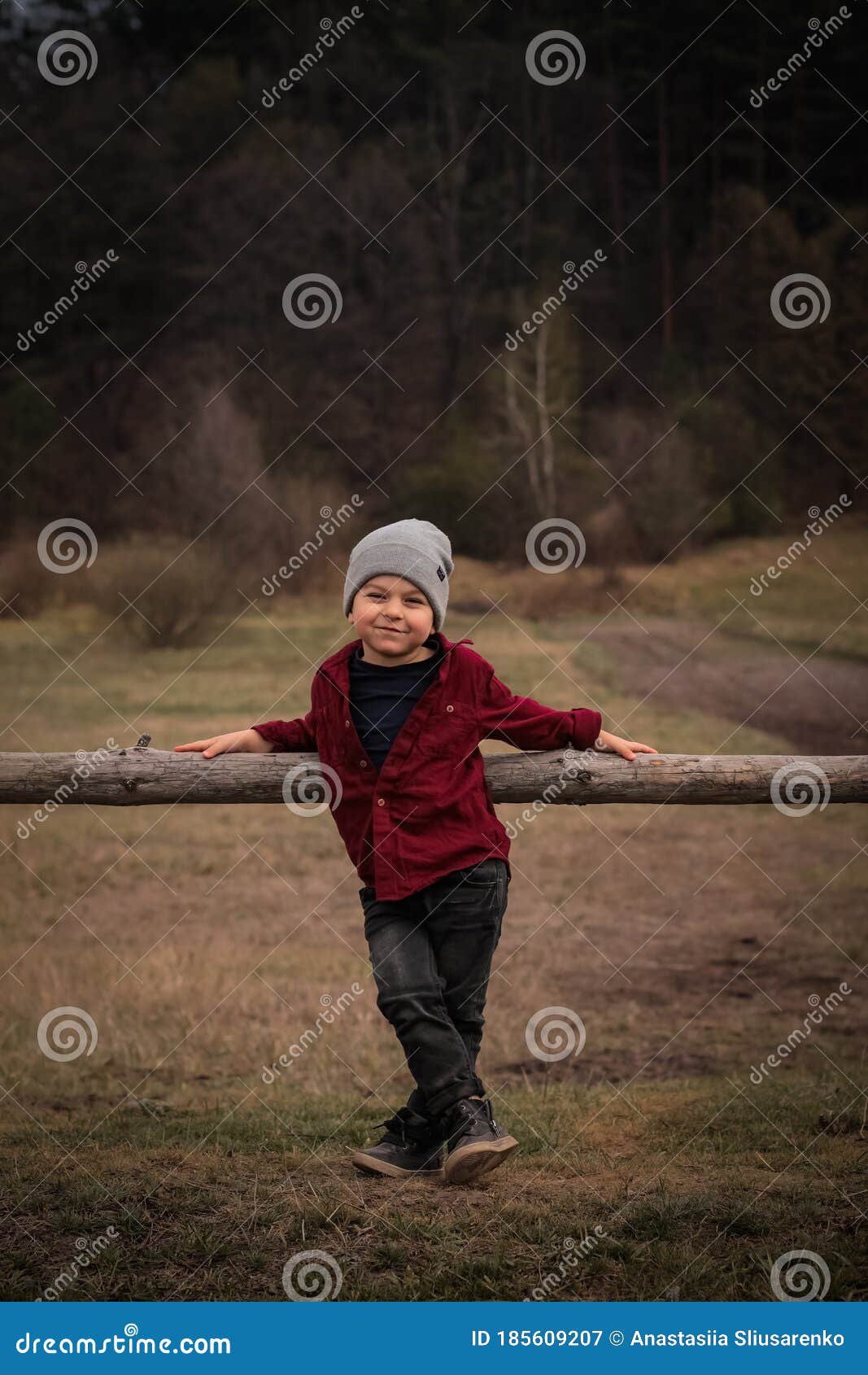 Cute Young Boy Holding a Log in the Spring Garden Stock Image - Image ...