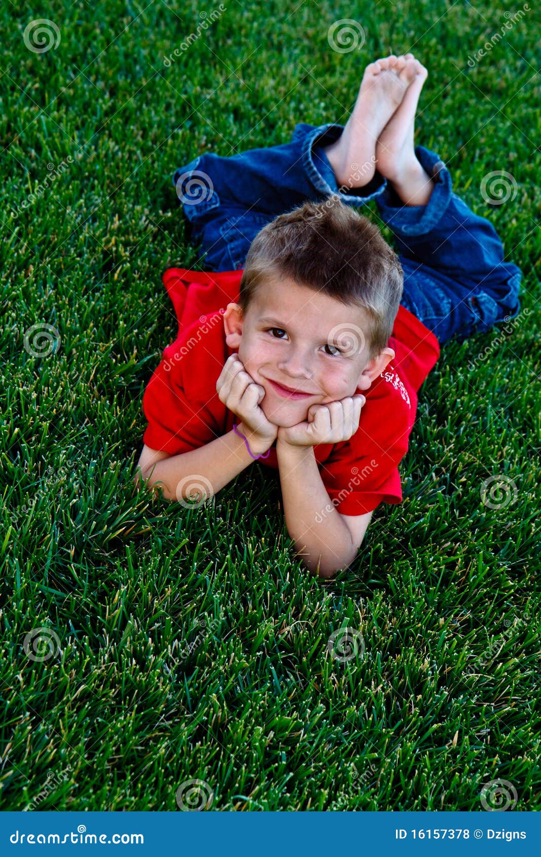 Cute Young Boy Lying in the Grass Stock Photo - Image of cheerful, full ...