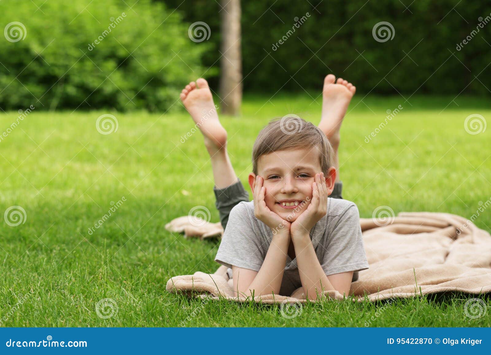 Cute Young Boy Resting on the Green Grass - Summer Time Stock Photo ...