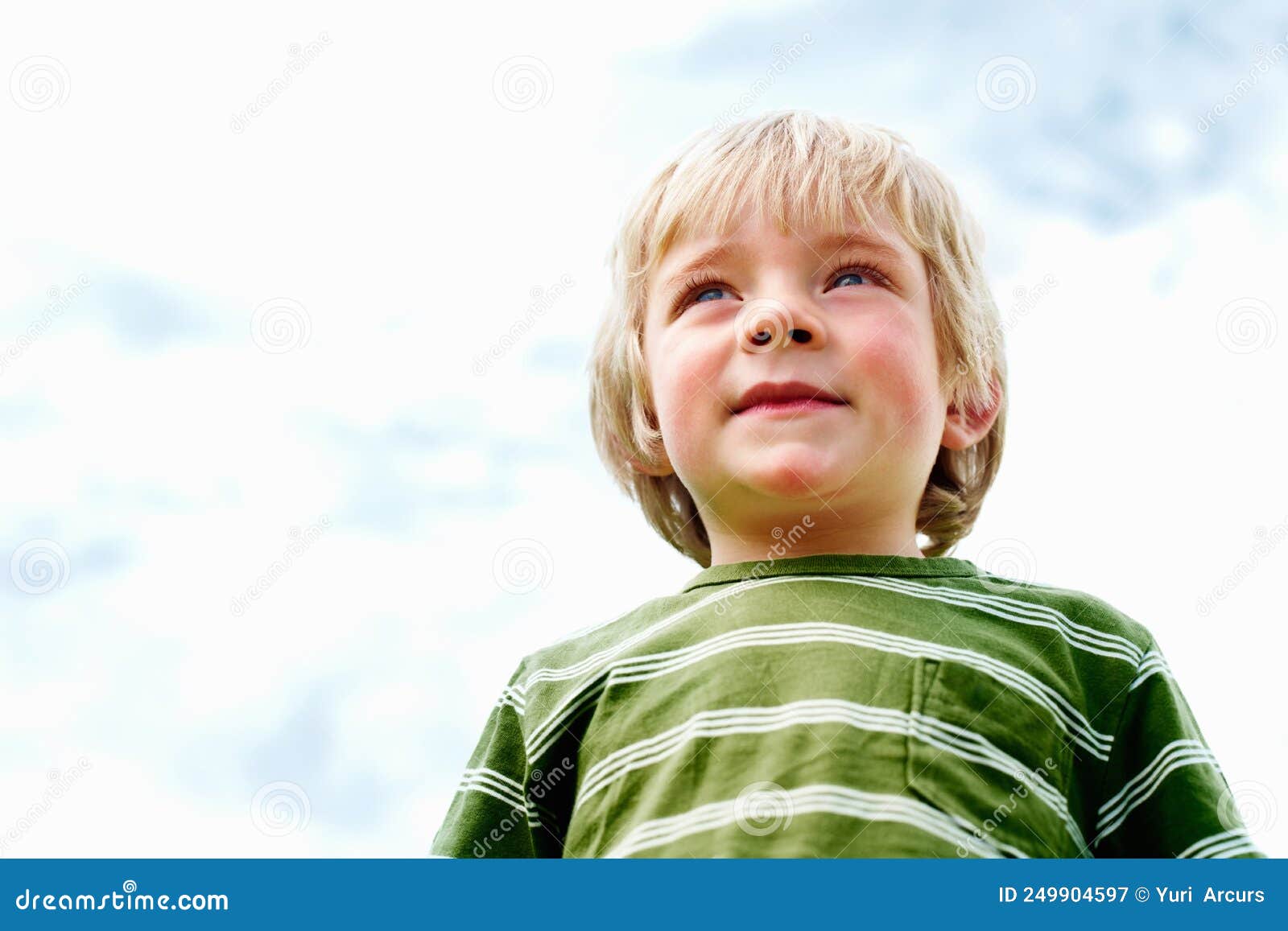 Cute Young Boy Smiling. Low Angle View of Cute Young Boy Standing ...