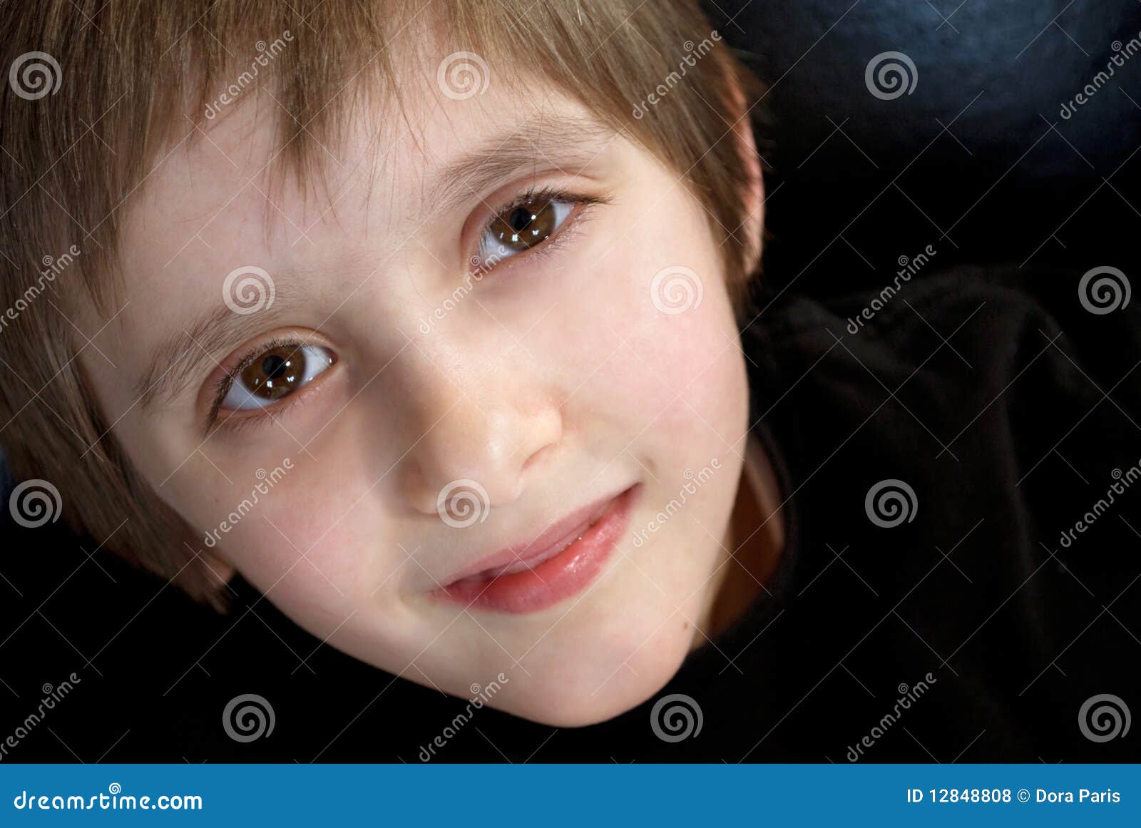 Cute Young Boy Smiling Up at Camera Stock Photo - Image of expression ...