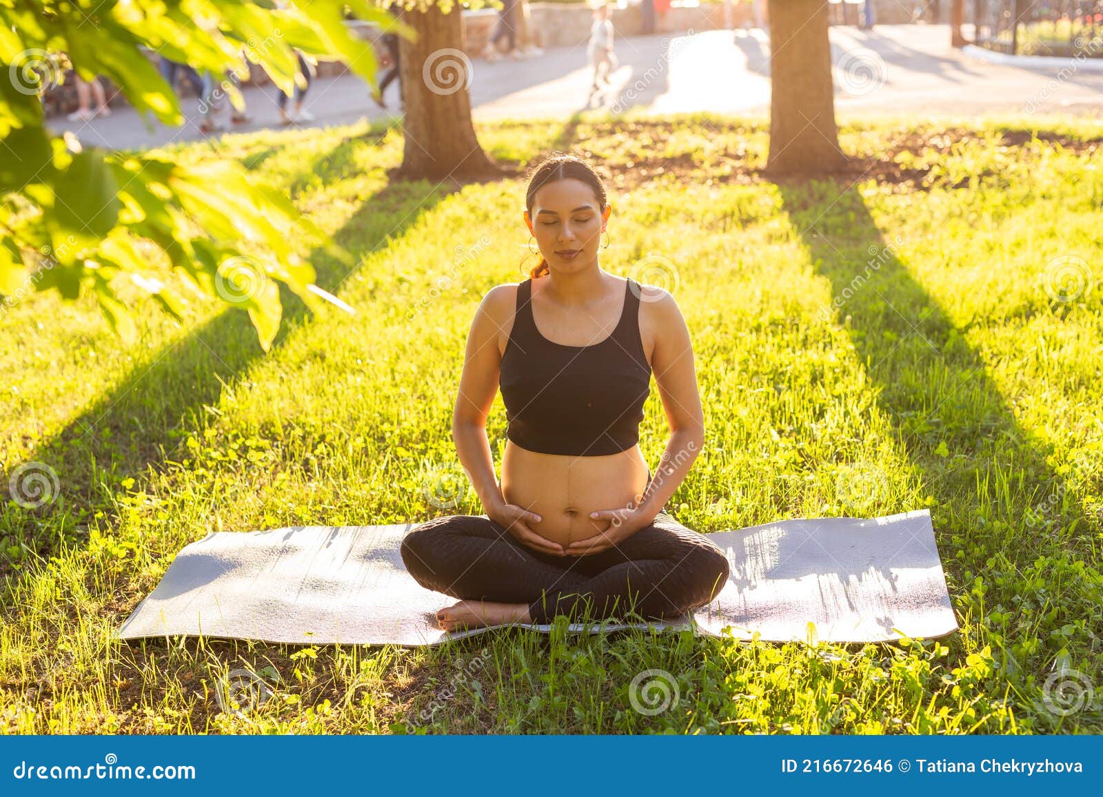 Cute Young Caucasian Pregnant Woman Is Meditating While Sitting On A