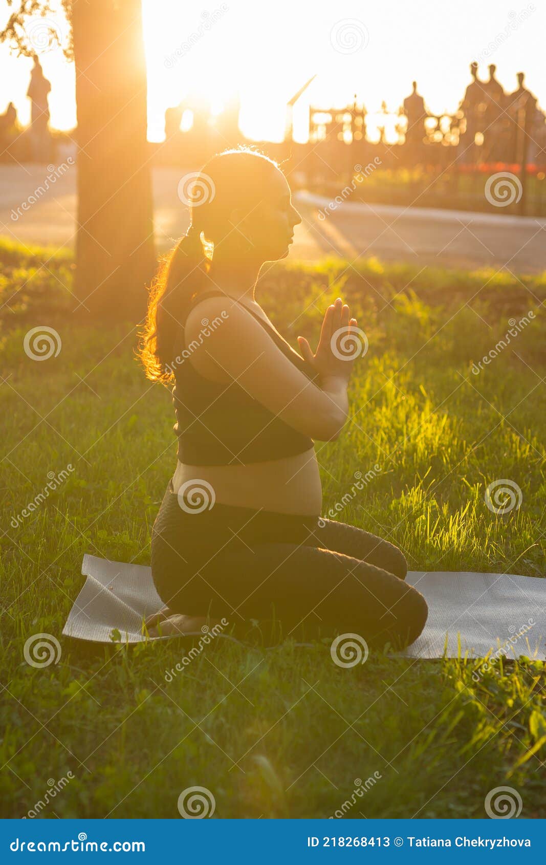 Cute Young Caucasian Pregnant Woman Is Meditating While Sitting On A
