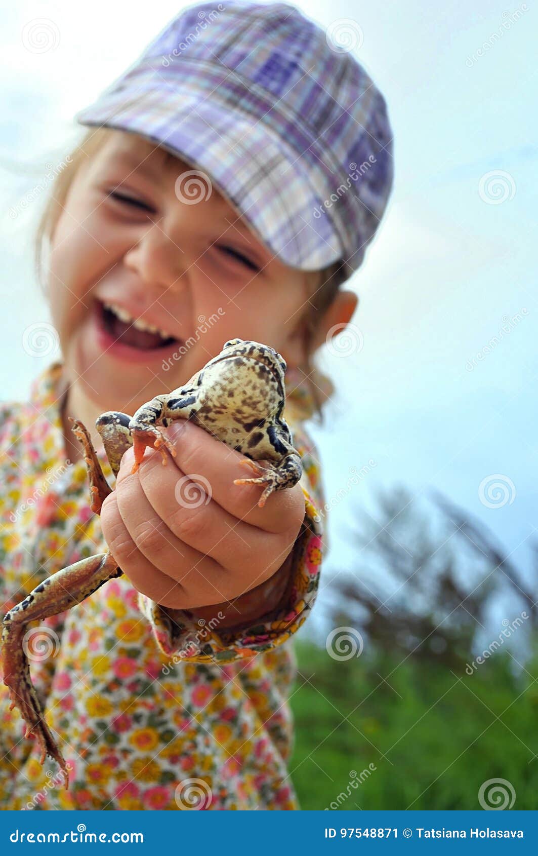 A Cute Young Child Girl Holding a Frog Toad in Hands and Laughing Stock ...