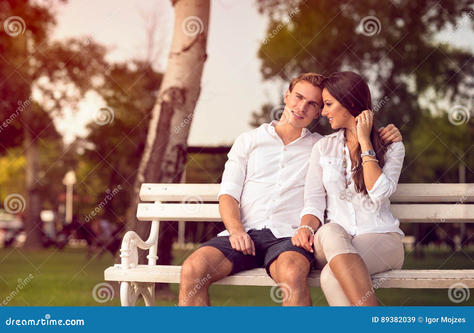 Cute Young Couple Sitting at Park Stock Image - Image of girl, friend ...