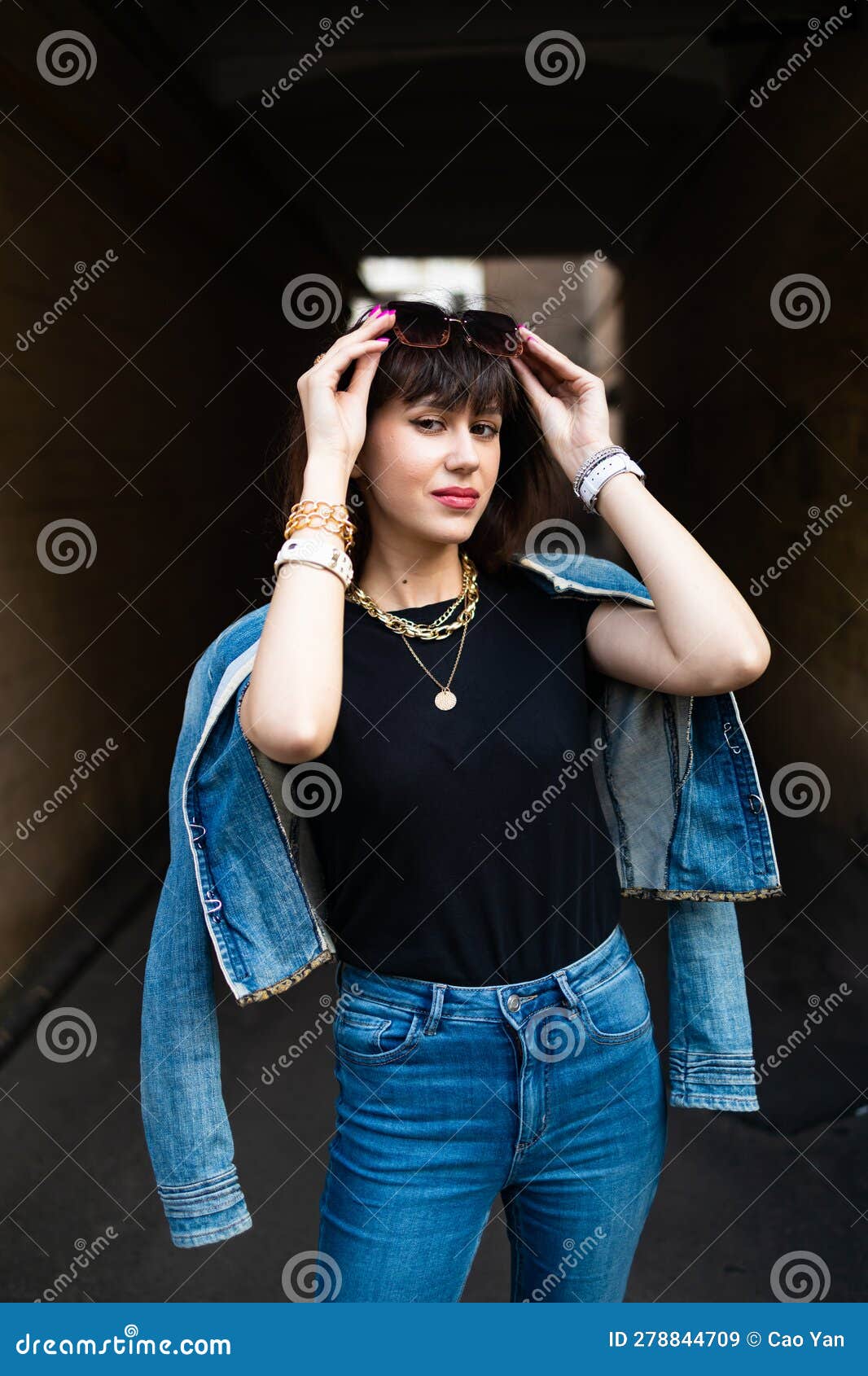 Cute Young Girl In Jeans Suit Wearing Sunglasses Posing In Arch In
