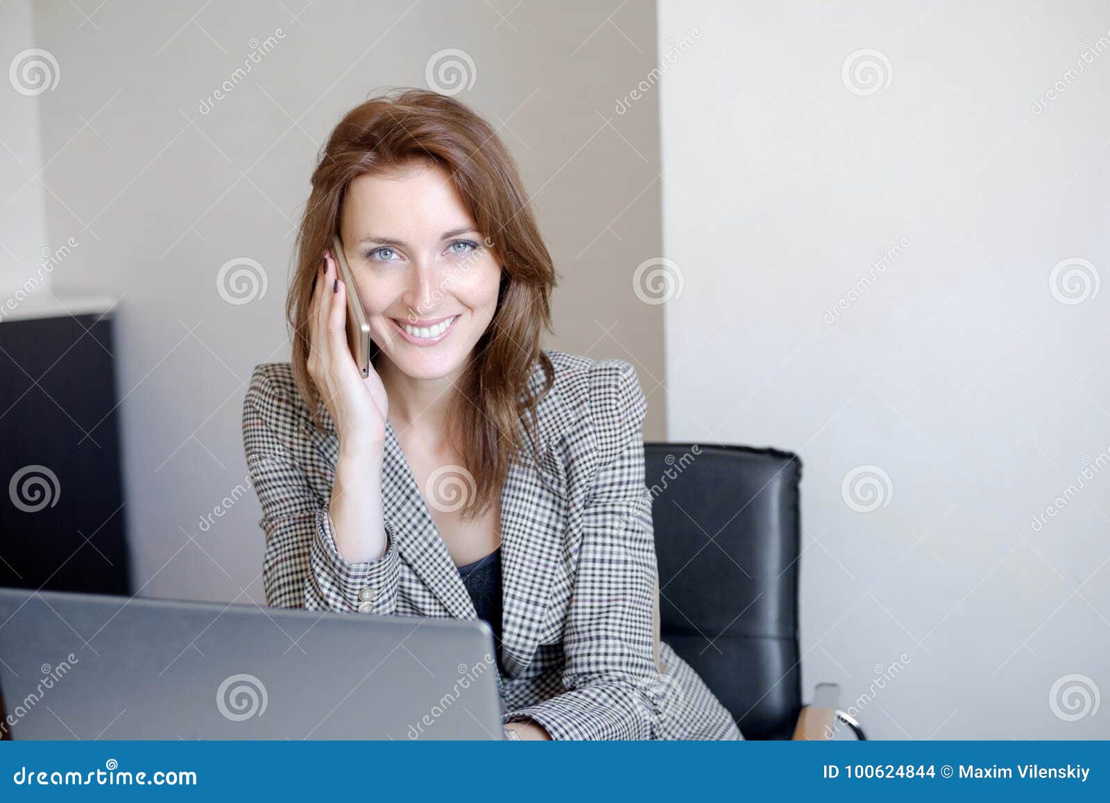 Cute Young Office Worker Talking on Cell Phone in Office Stock Photo ...