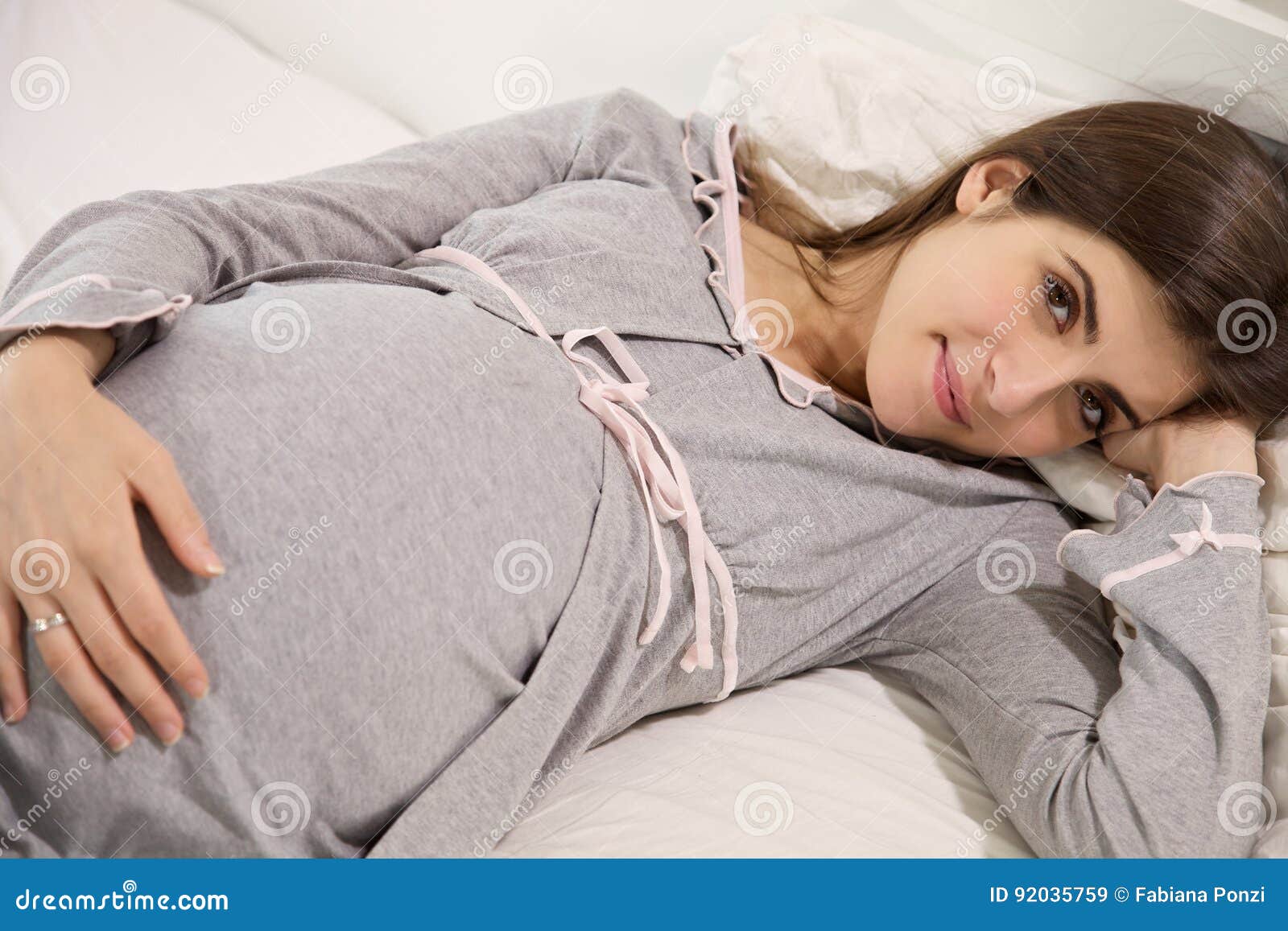 Cute Young Pregnant Woman Smiling Looking Camera Lying In Bed Stock