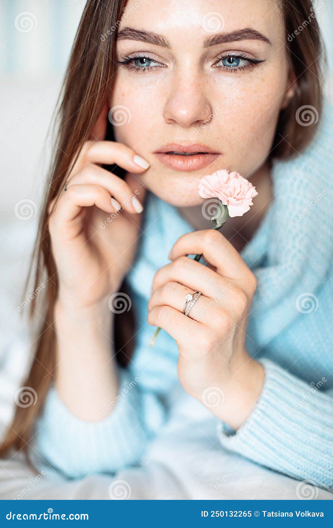 Cute Young Woman Holding Delicate Flower In Hand Near Face Closeup