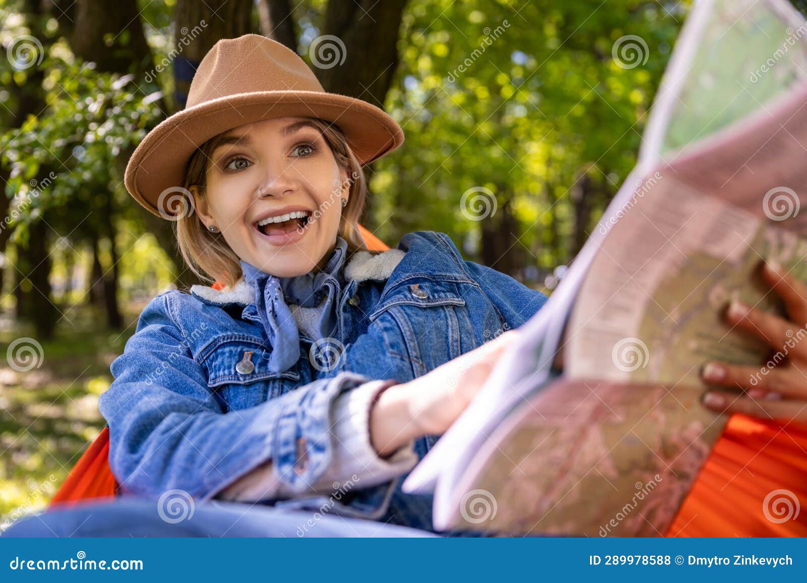 Cute Young Woman with a Map in Hands Looking for New Destination Stock ...