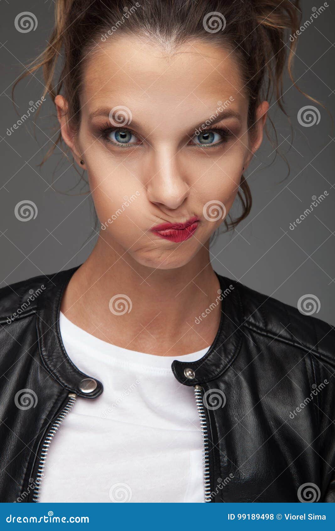 Cute young woman smirking stock photo. Image of grey - 99189498