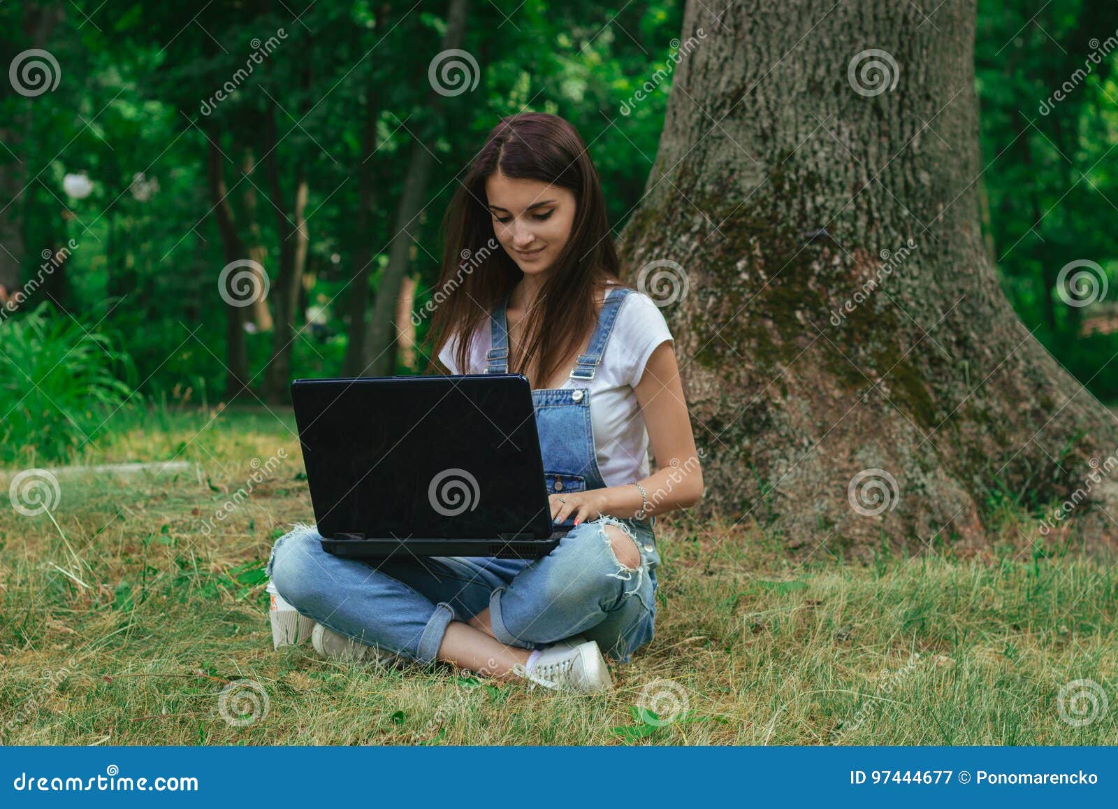 Cutie Young Girl Using a Laptop and Sits on a Grass Stock Image - Image ...