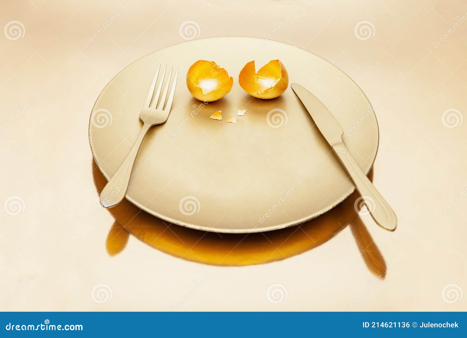 Cutlery and Golden Eggshell on Plate Placed on Reflective Table Stock ...