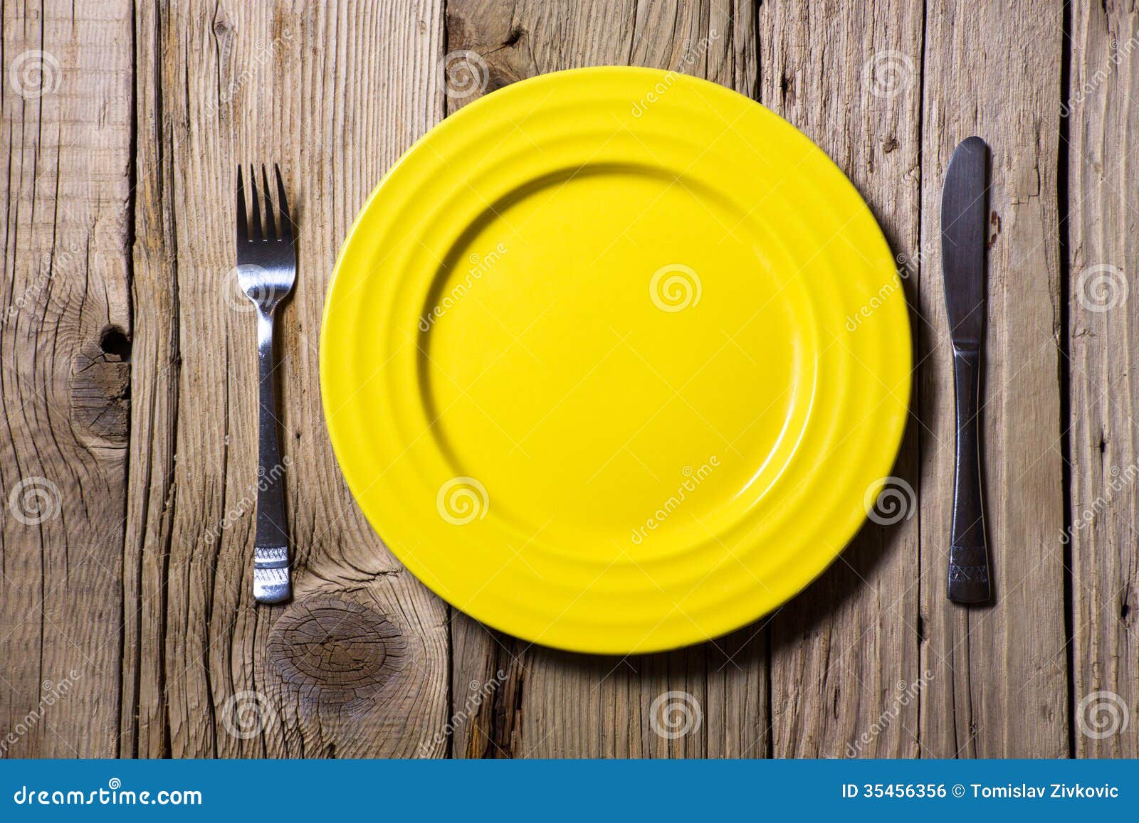 Cutlery and Yellow Plate on Wooden Stock Photo - Image of yellow ...