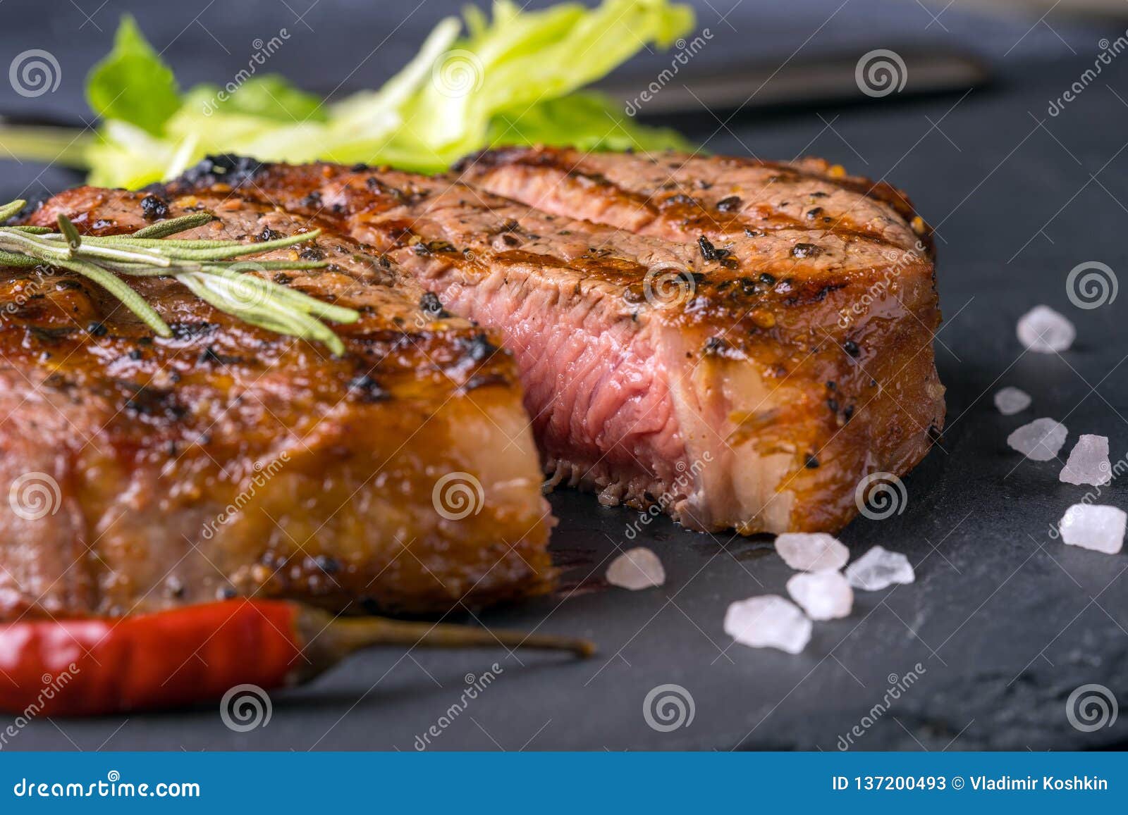 A ribeye steak with green stock image. Image of black - 137200493