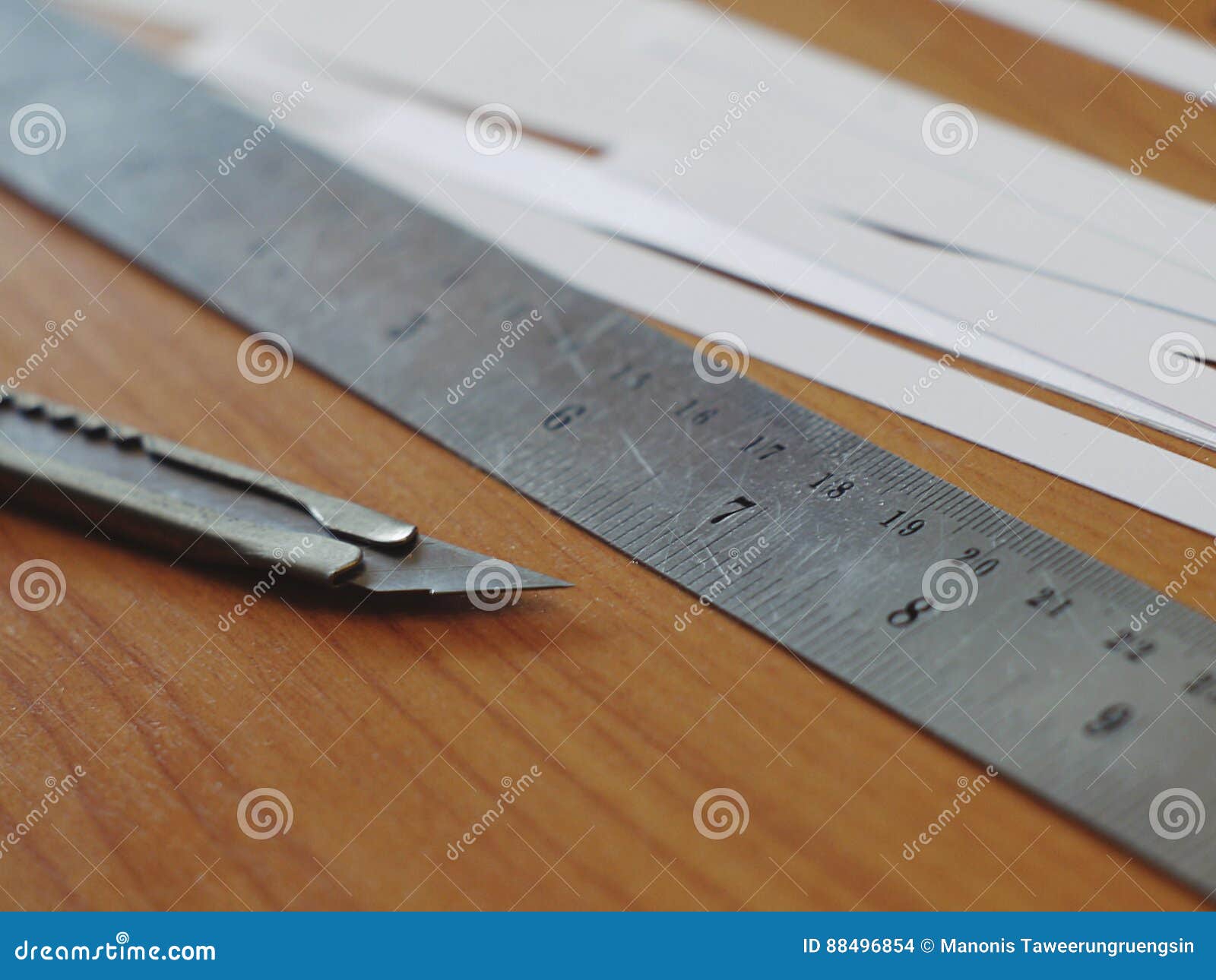 Cutter Knife with Stainless Ruler and Strip of White Paper Stock Photo ...