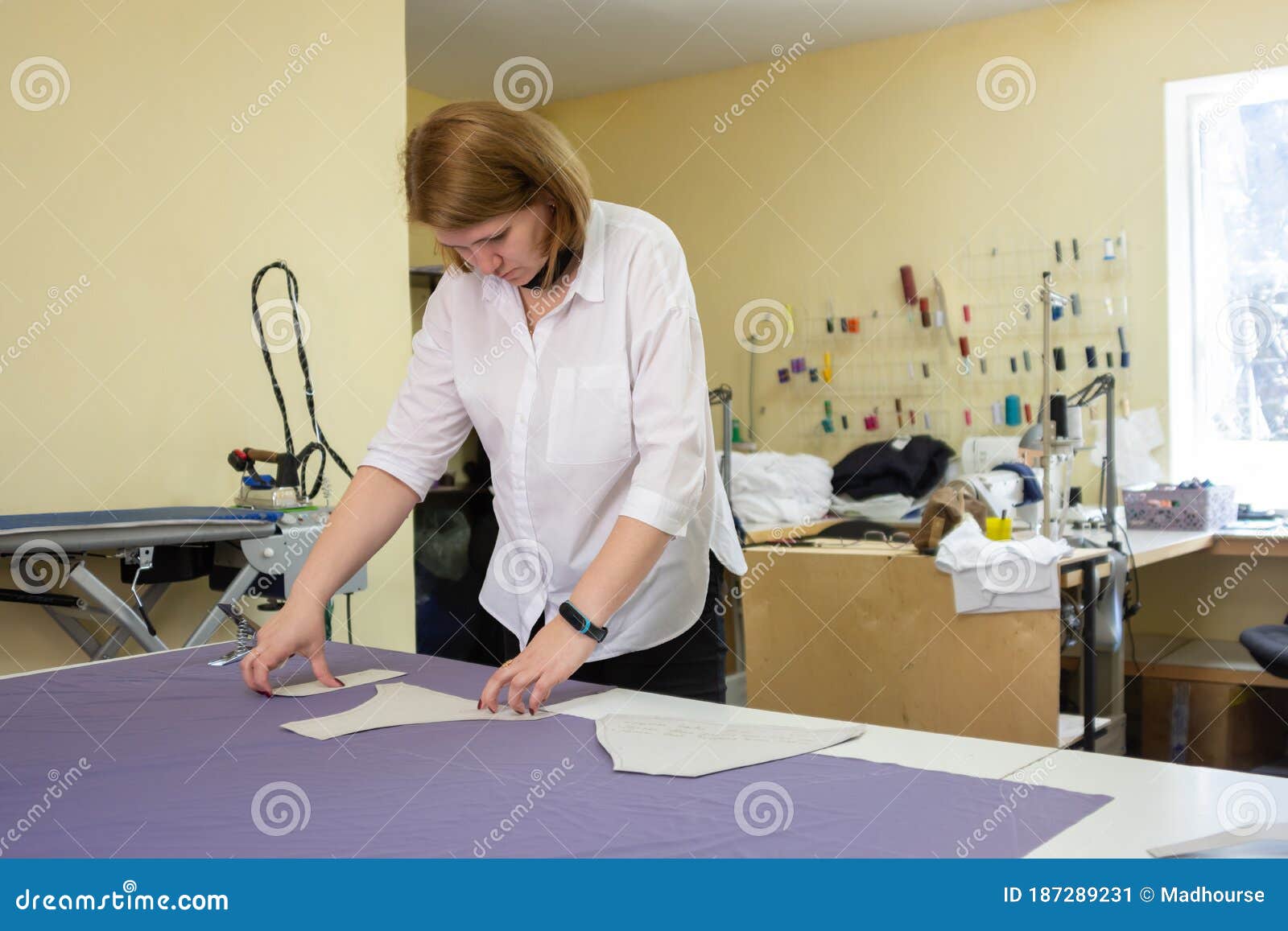 The Cutter Lays Out the Patterns on the Matter on a Large Table in the ...