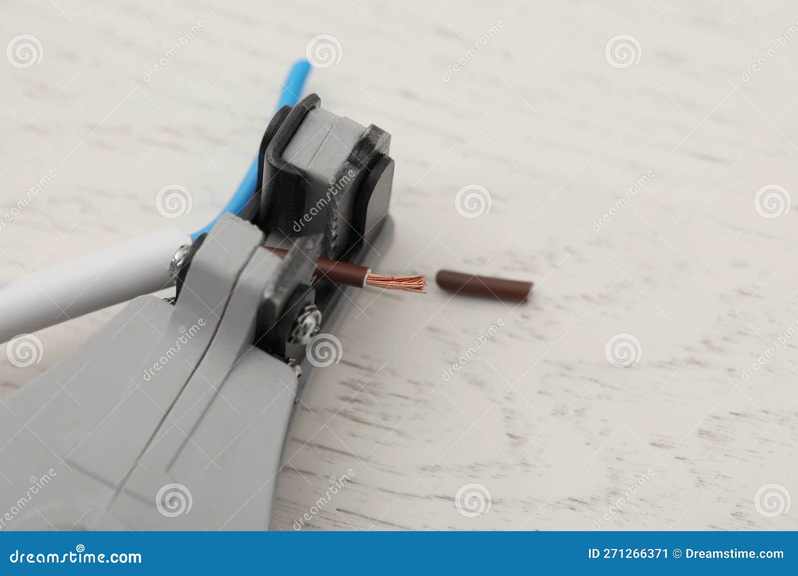 Cutters and Stripped Wire on White Wooden Table, Closeup. Space for ...