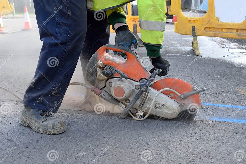 CUTTING ASPHALT stock photo. Image of tool, manual, active - 67180516