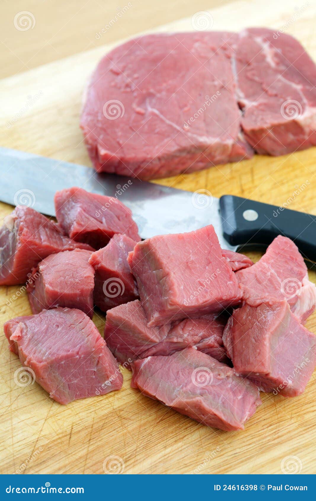 Cutting beef into cubes stock photo. Image of beef, vertical - 24616398