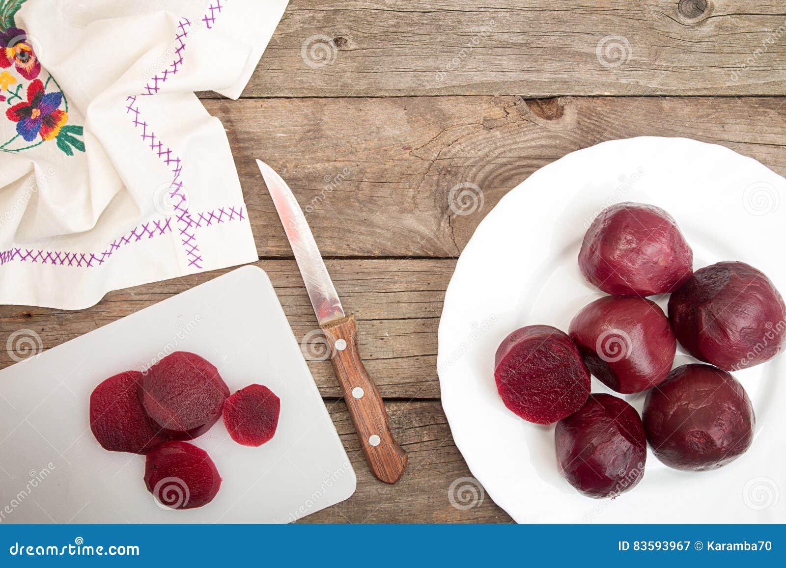 Cutting Beetroot on White Chopping Board Over on Old Wooden Table ...