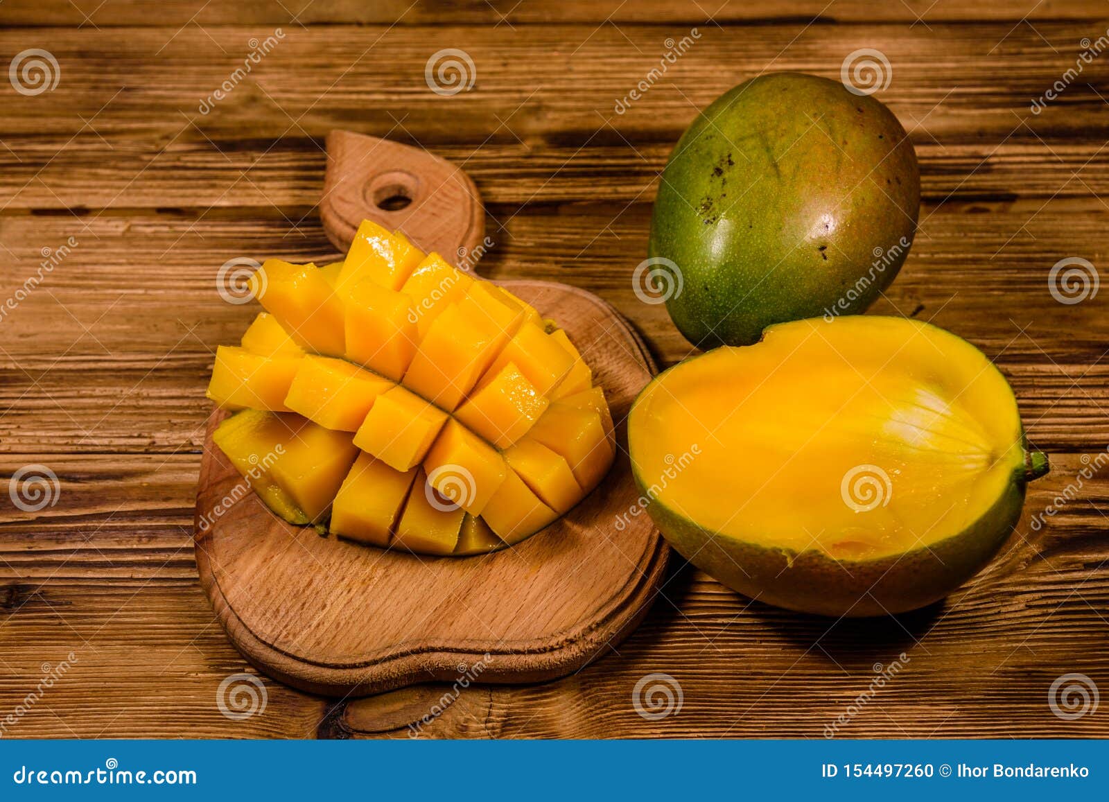 Cutting Board with Chopped Mango Fruit on a Wooden Table Stock Photo ...