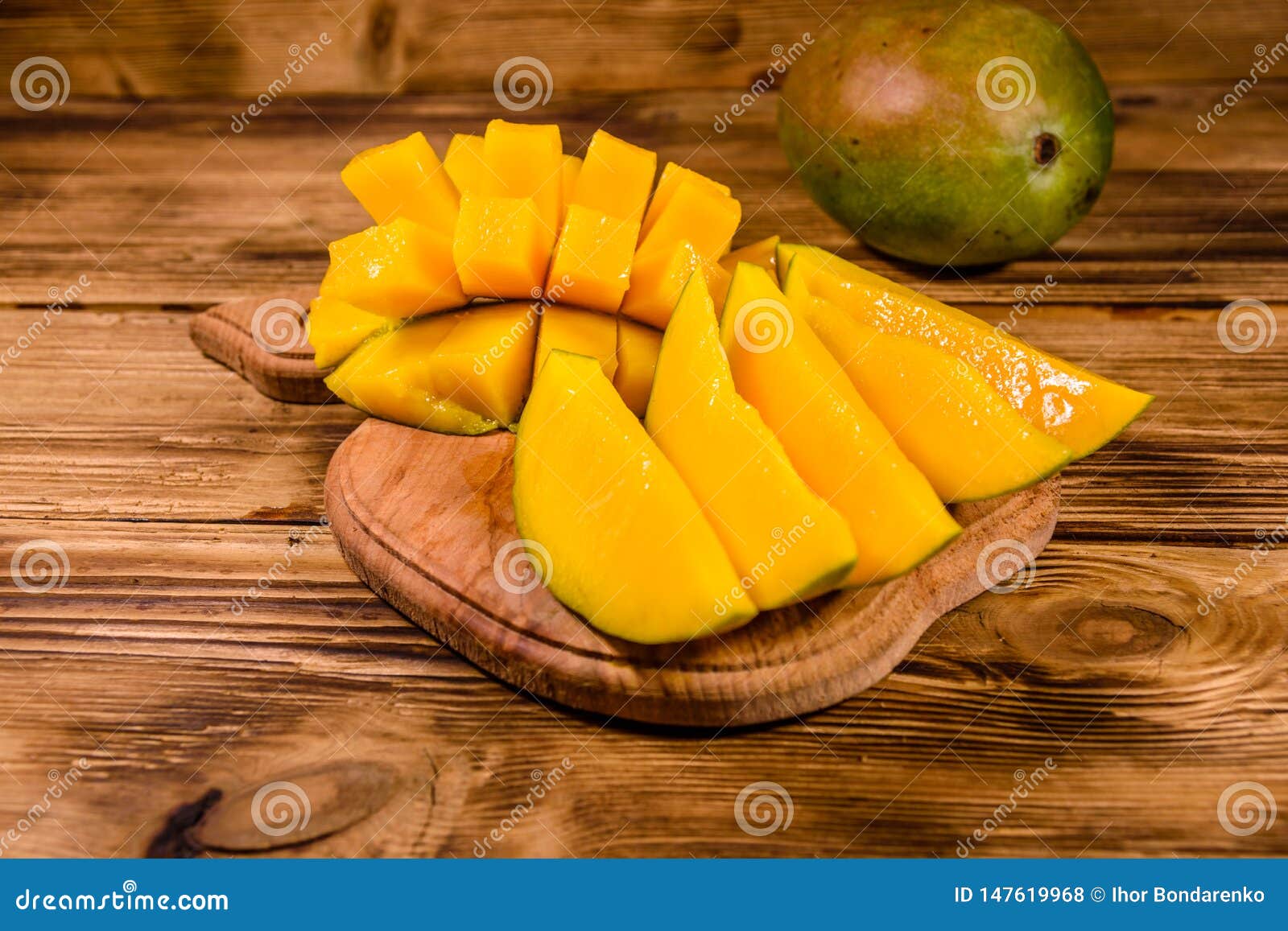 Cutting Board with Chopped Mango Fruit on a Wooden Table Stock Photo ...