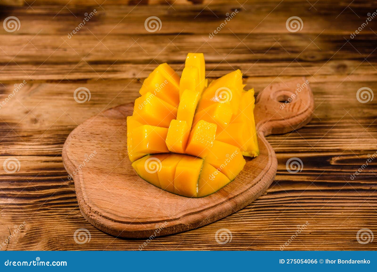 Cutting Board with Chopped Mango Fruit on a Wooden Table Stock Photo ...