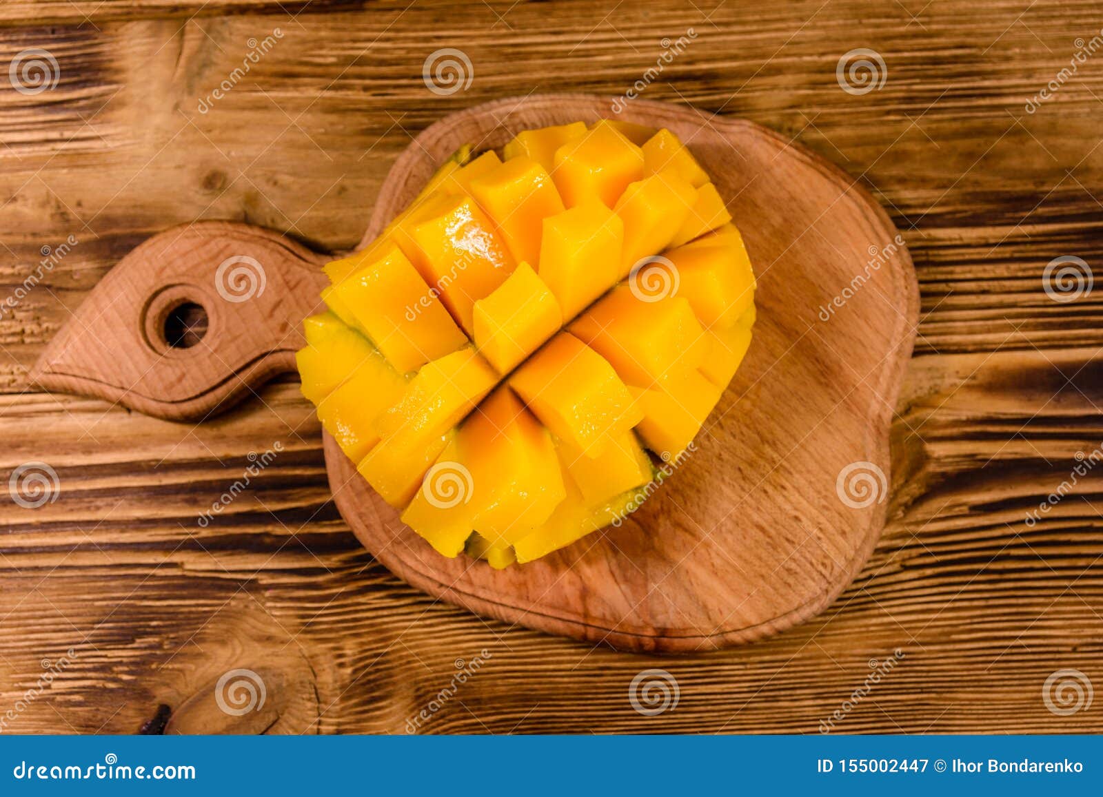 Cutting Board with Chopped Mango Fruit on a Wooden Table. Top View ...