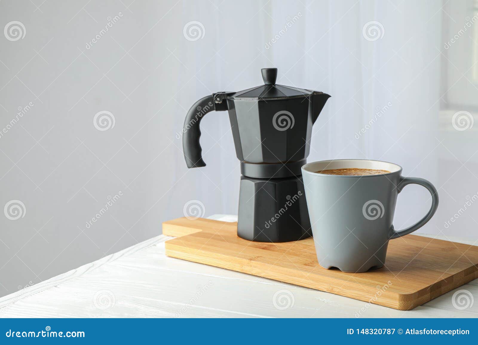 Cutting Board with Cup of Fresh Coffee and Coffee Maker on White Table ...