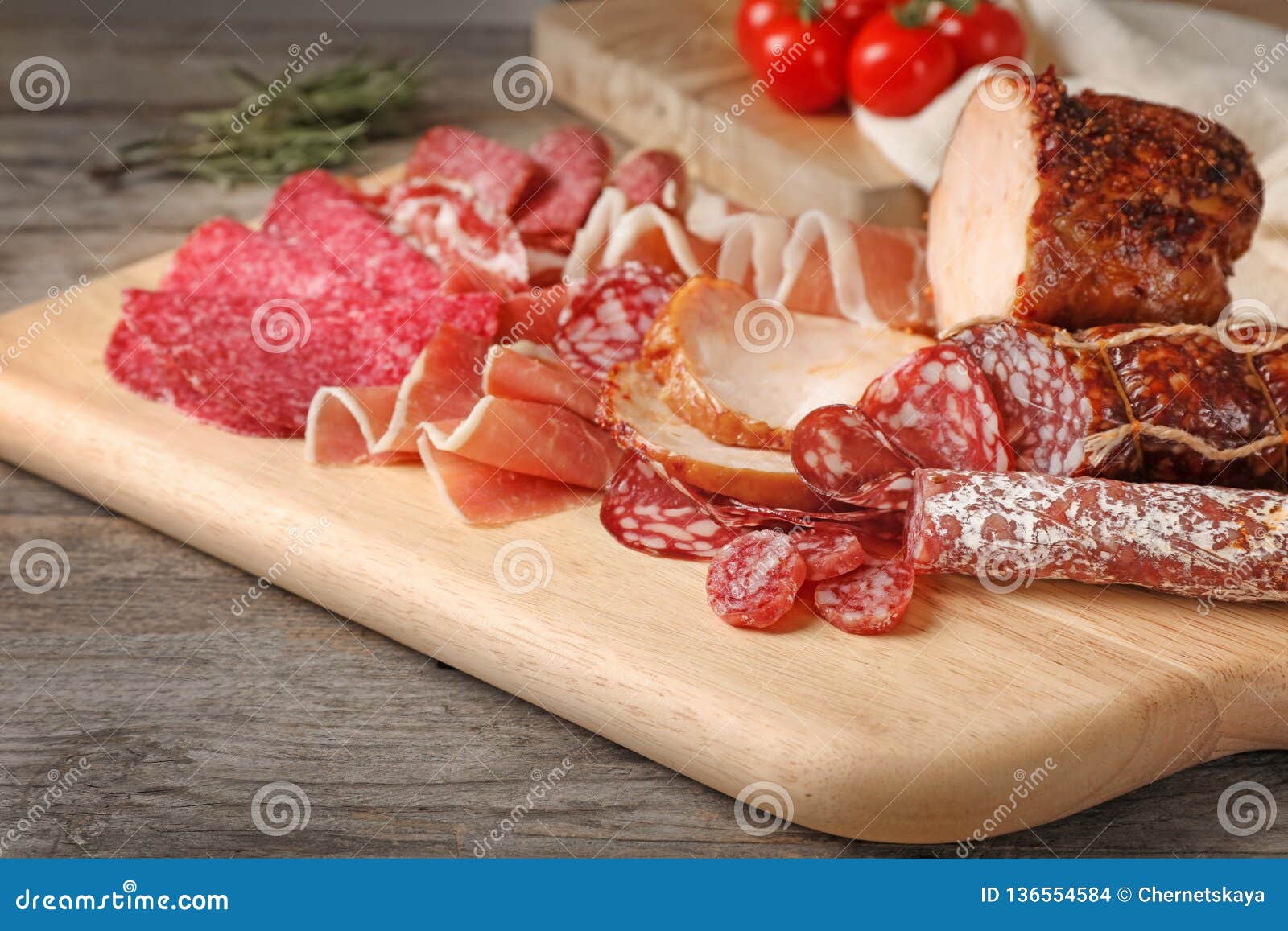 Cutting Board with Different Meat Delicacies on Table Stock Photo ...