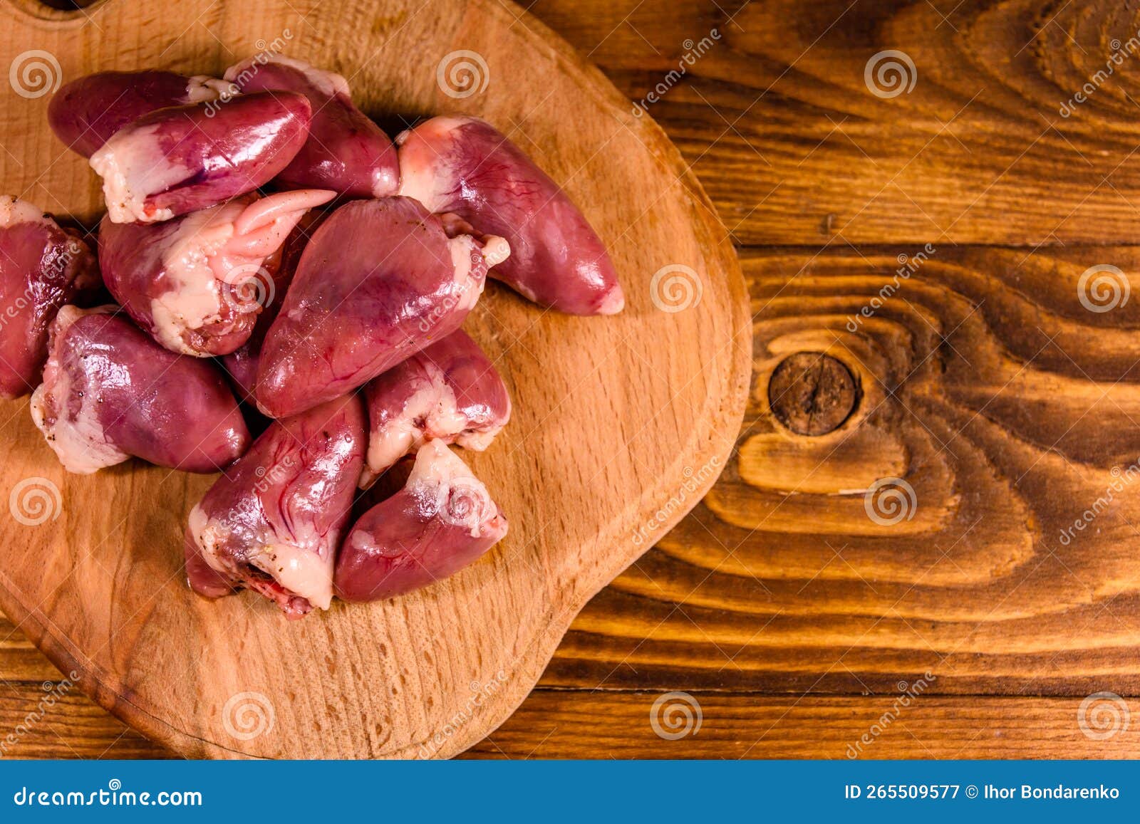 Cutting Board with Raw Chicken Hearts on Wooden Table. Top View Stock ...