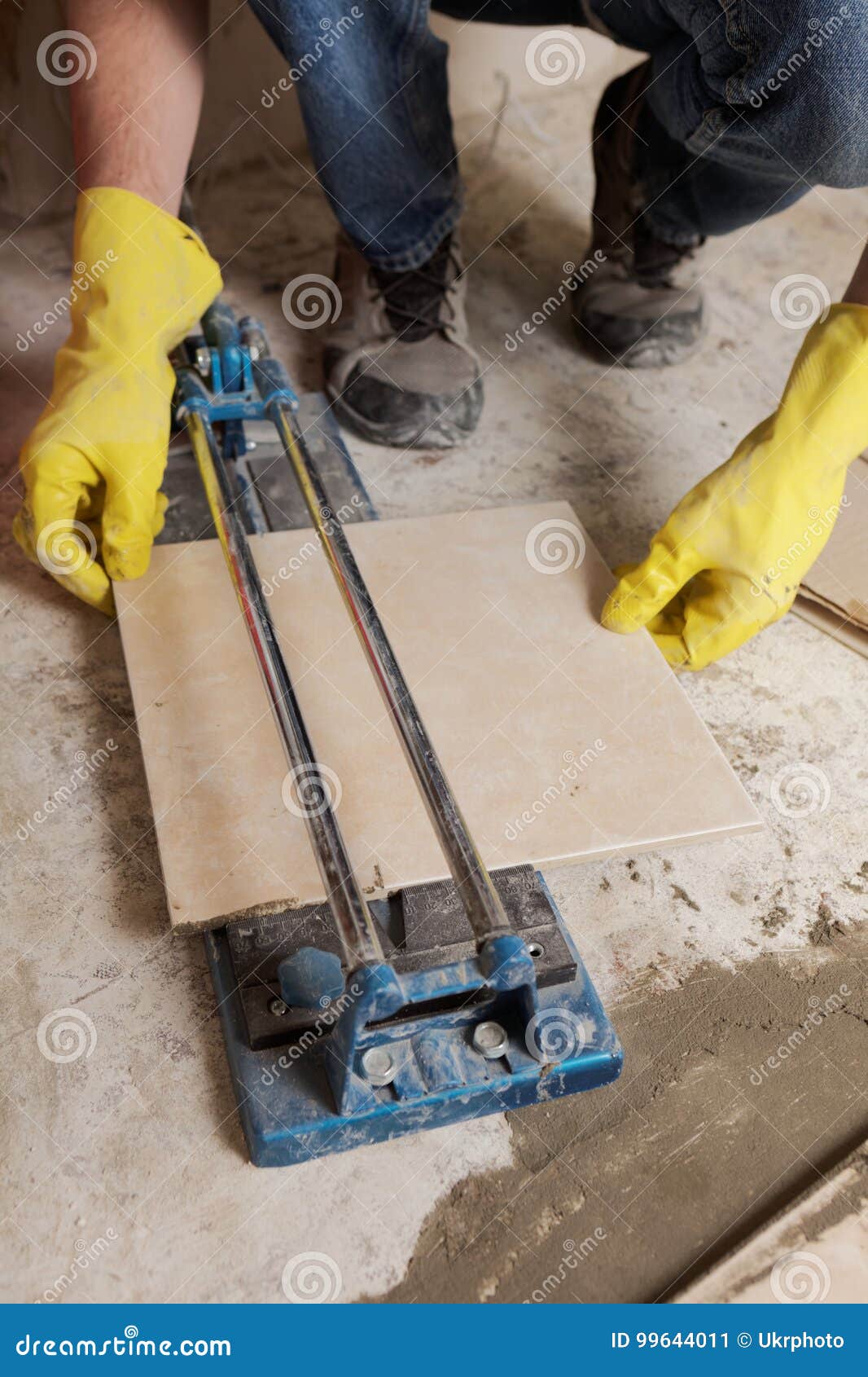 Cutting ceramic tiles stock image. Image of contractor - 99644011