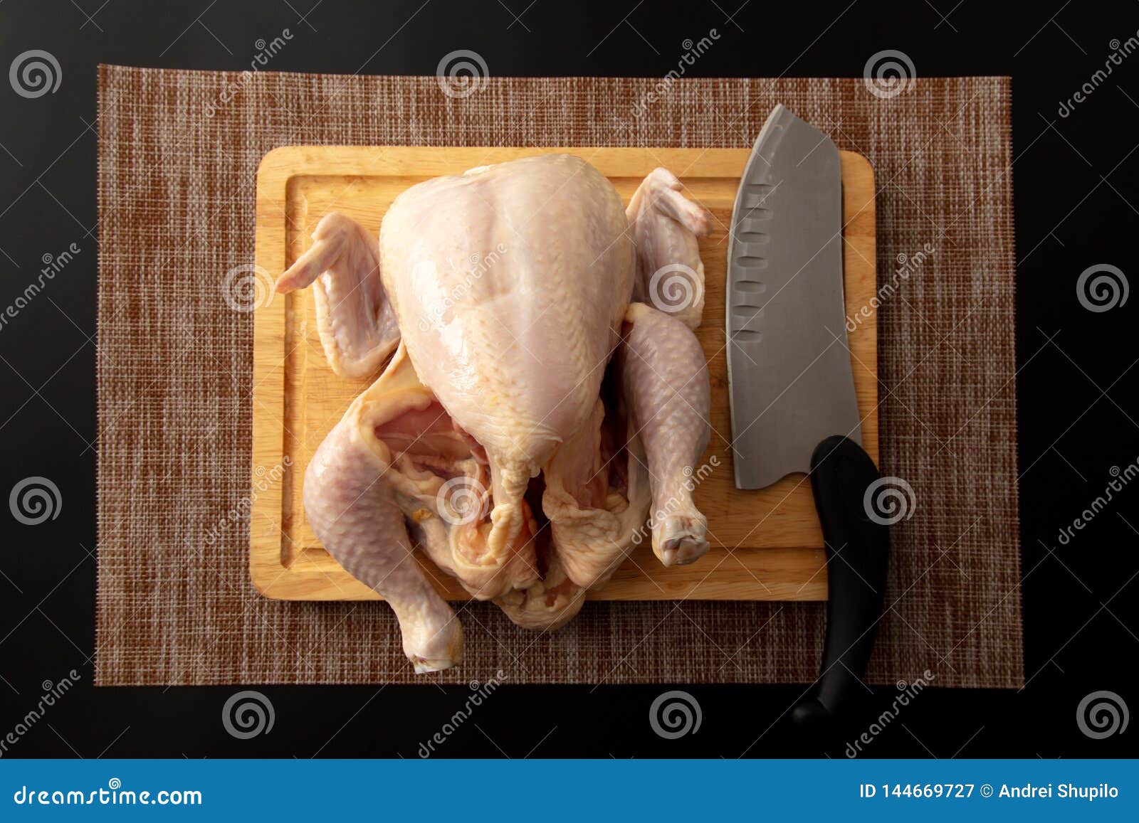 Cutting Chicken Carcass on a Board on a Black Background Stock Image ...