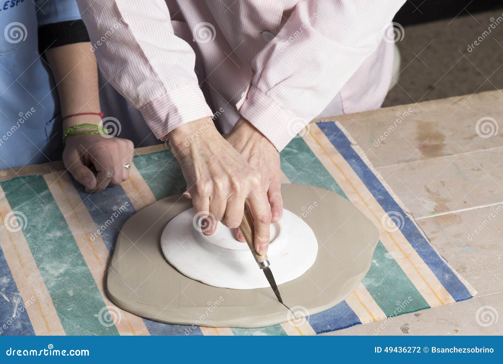Cutting the clay to shape stock photo. Image of work - 49436272